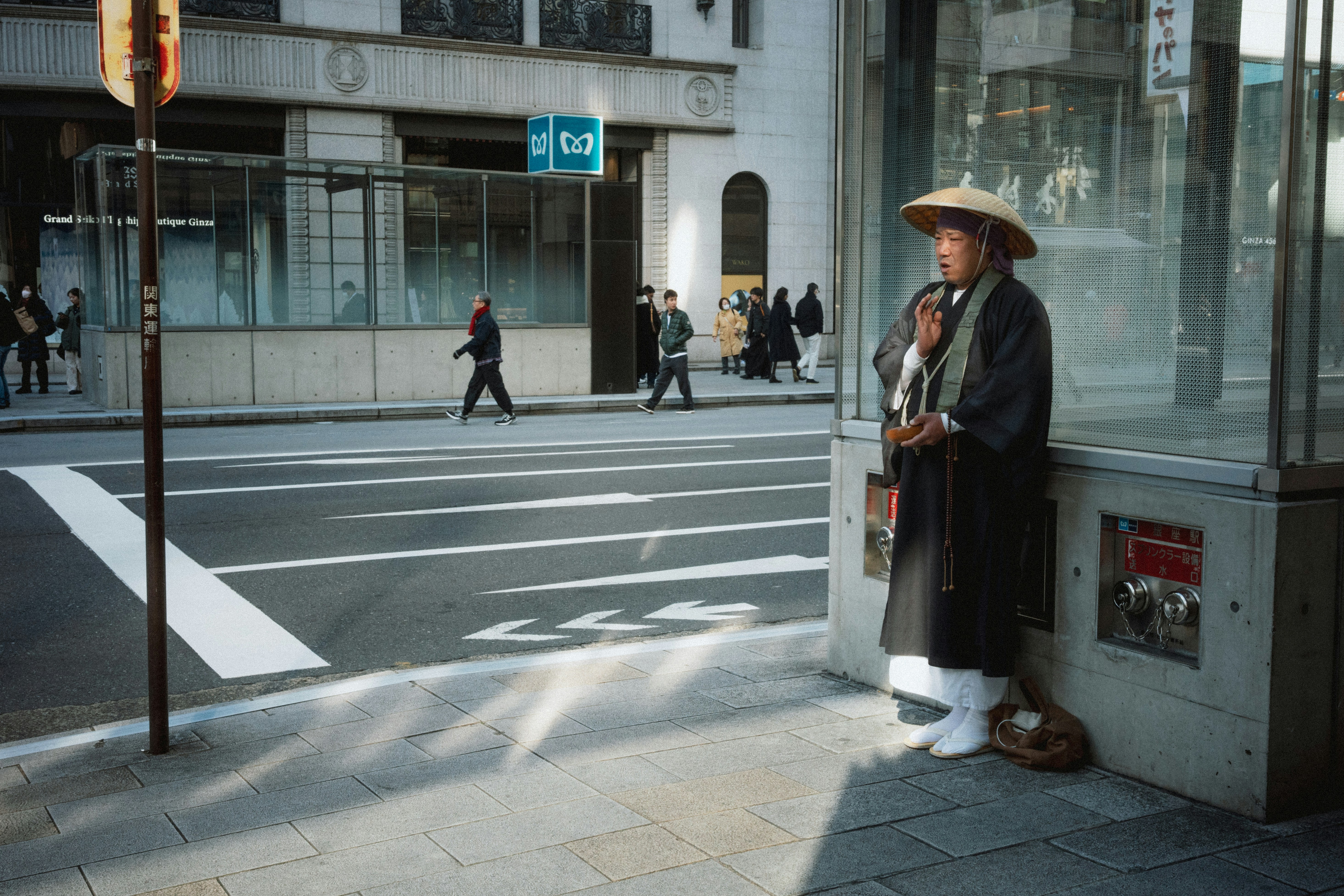 Street Sutra: The Robed Stranger at the Edge of the Glass Box