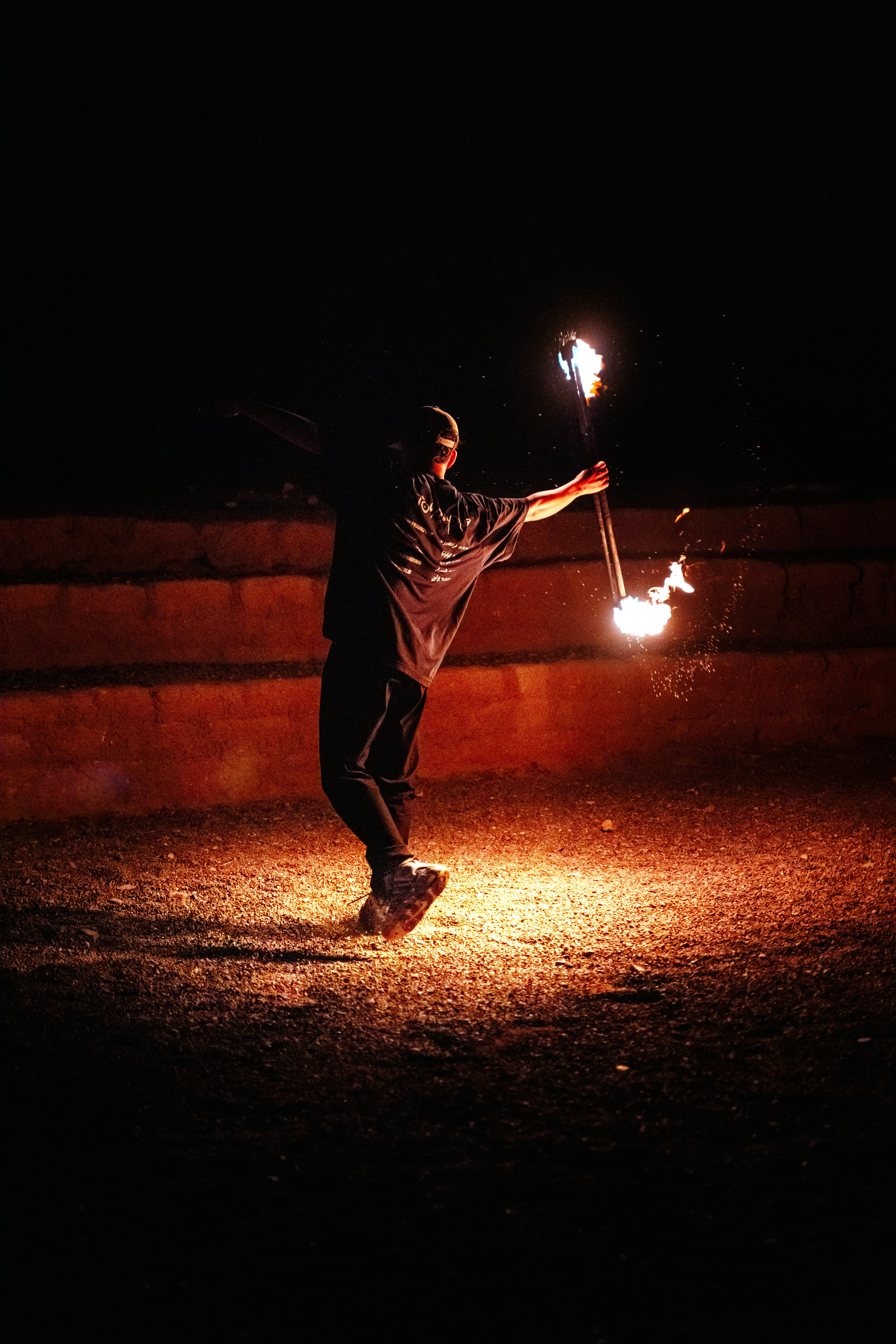 Midnight Fire: A Solo Performer Wields Light by the Shoreline