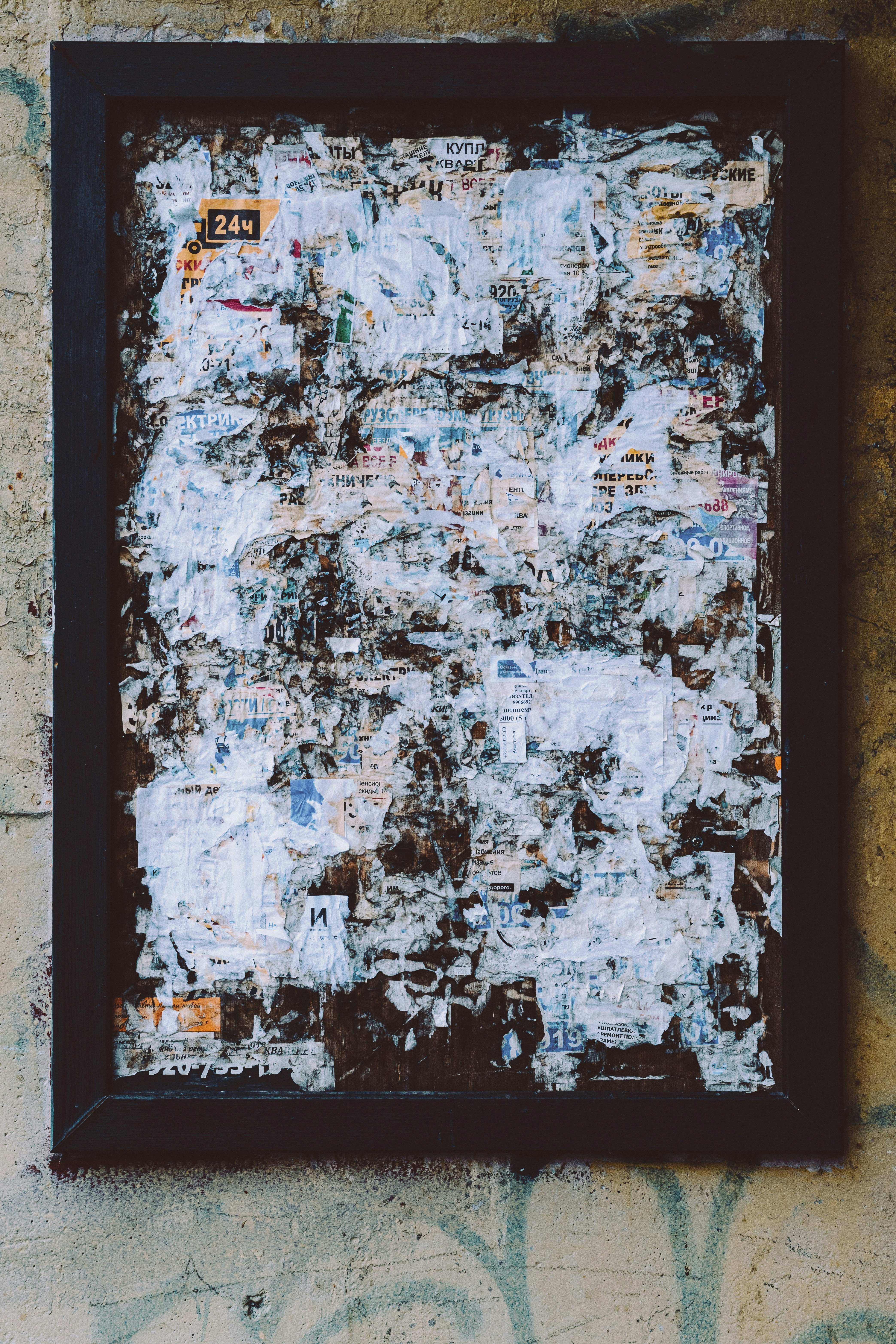 A Fragmented Doorway: Layered Posters on a Weathered Frame