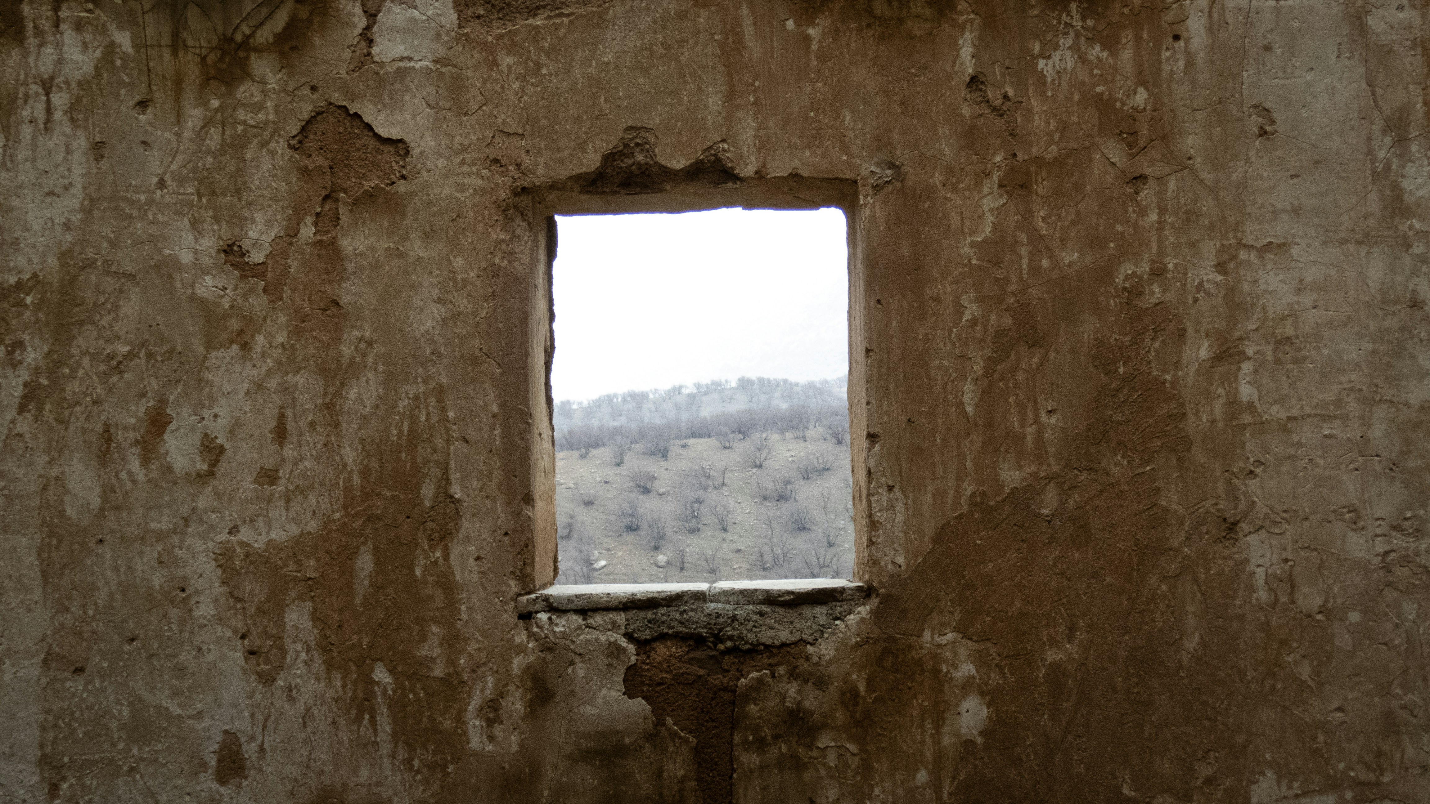 Window to the horizon: a weathered ruin frames distant hills