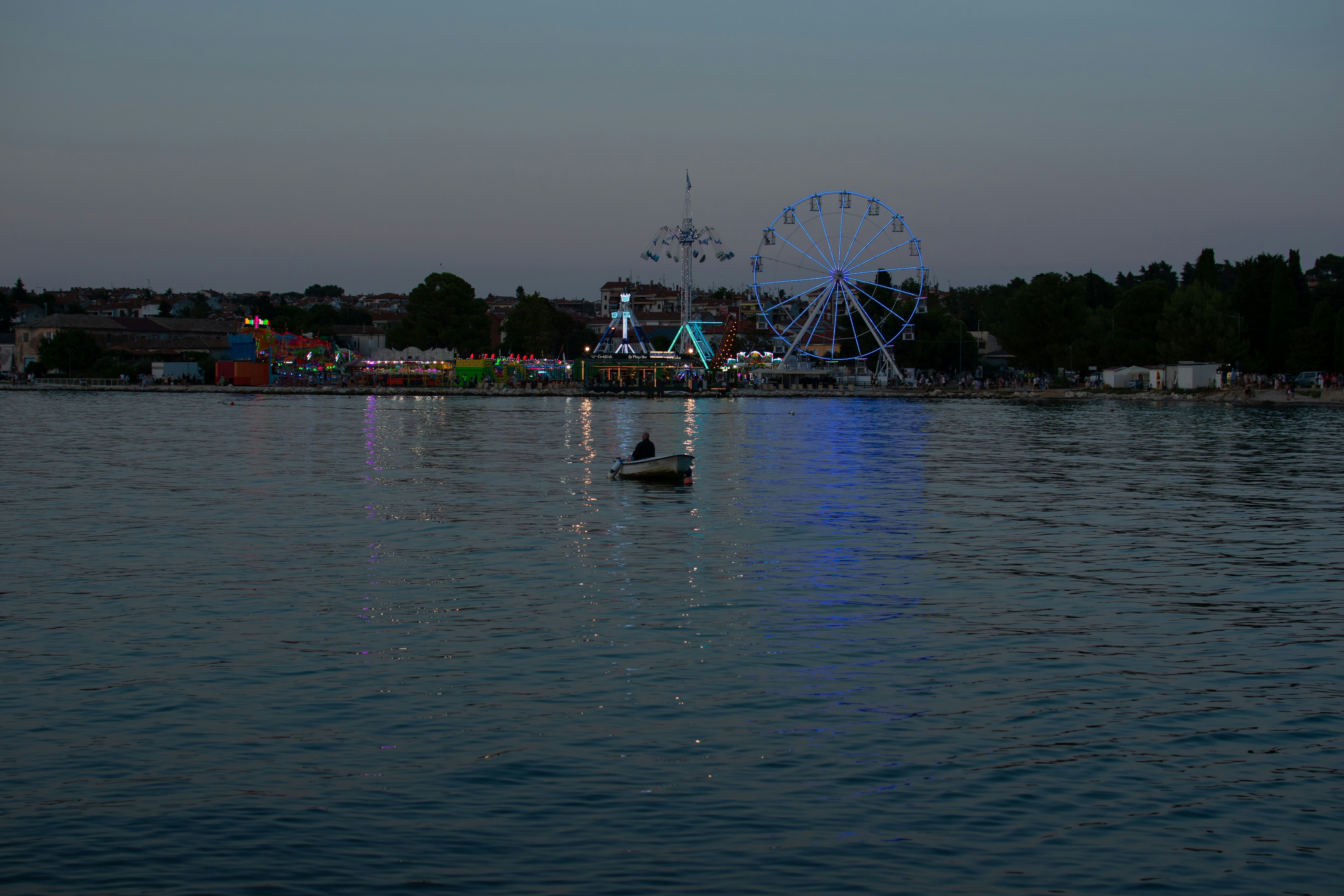 Glow on the Pier: Evening Lights Reflect on a Summer Lake