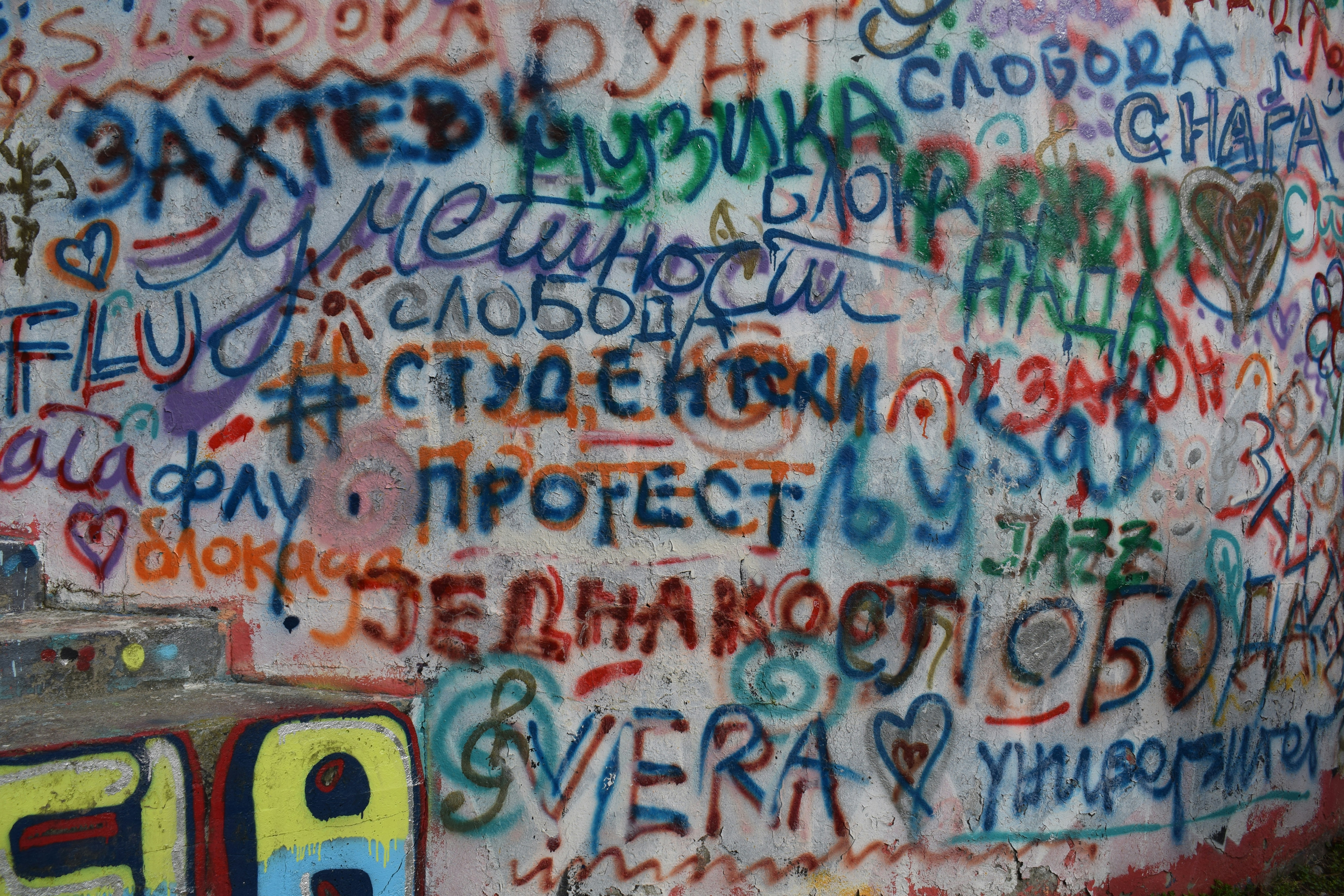 Crimson Scribbles: A Wall of Voices in Colorful Graffiti
