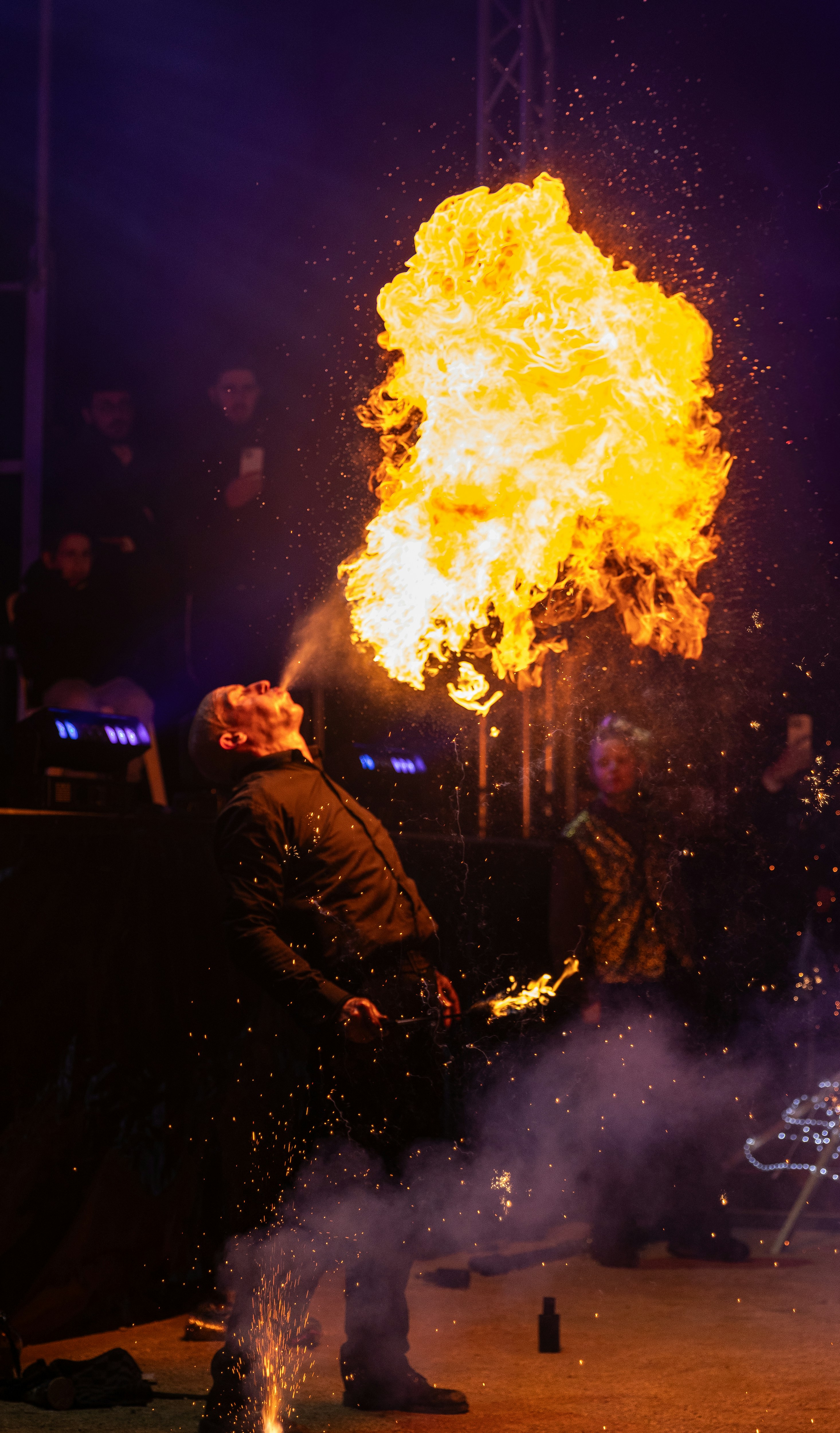 Fire-breathing performance: a dancer amid a plume of flame