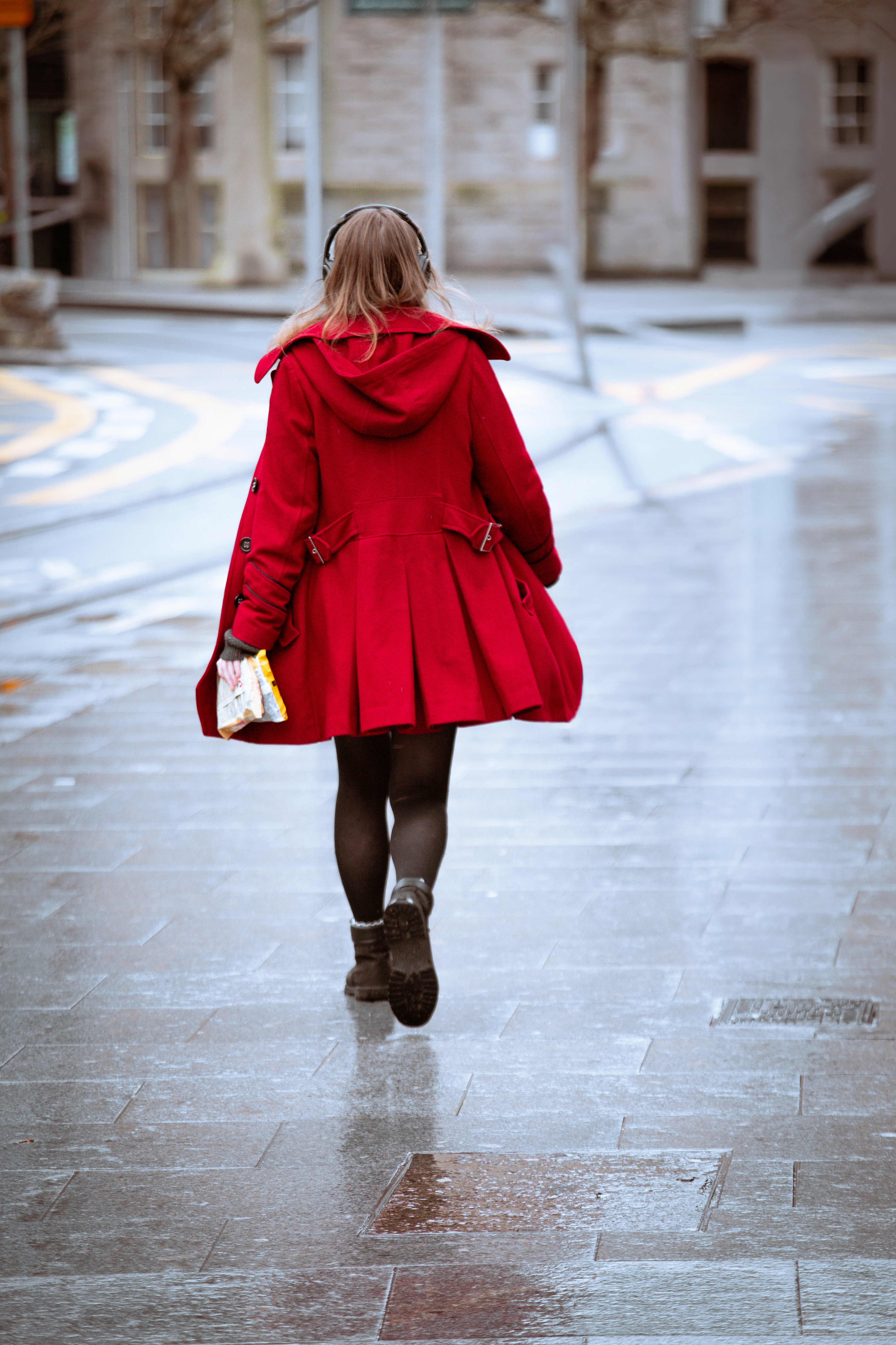 Red Coat in the Rain: A Quiet Departure Down the City Avenue