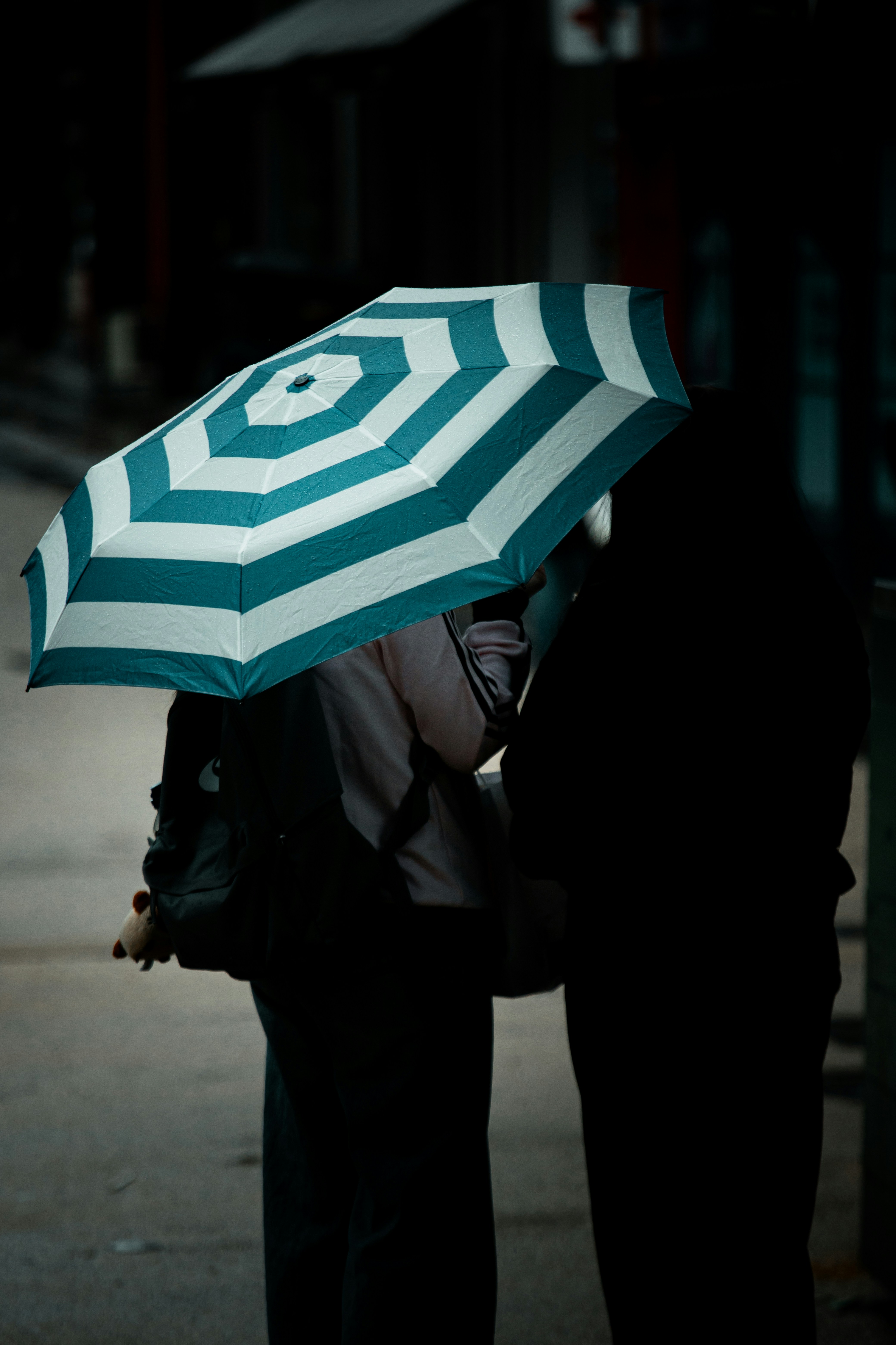 Teal Stripes Under a City Umbrella