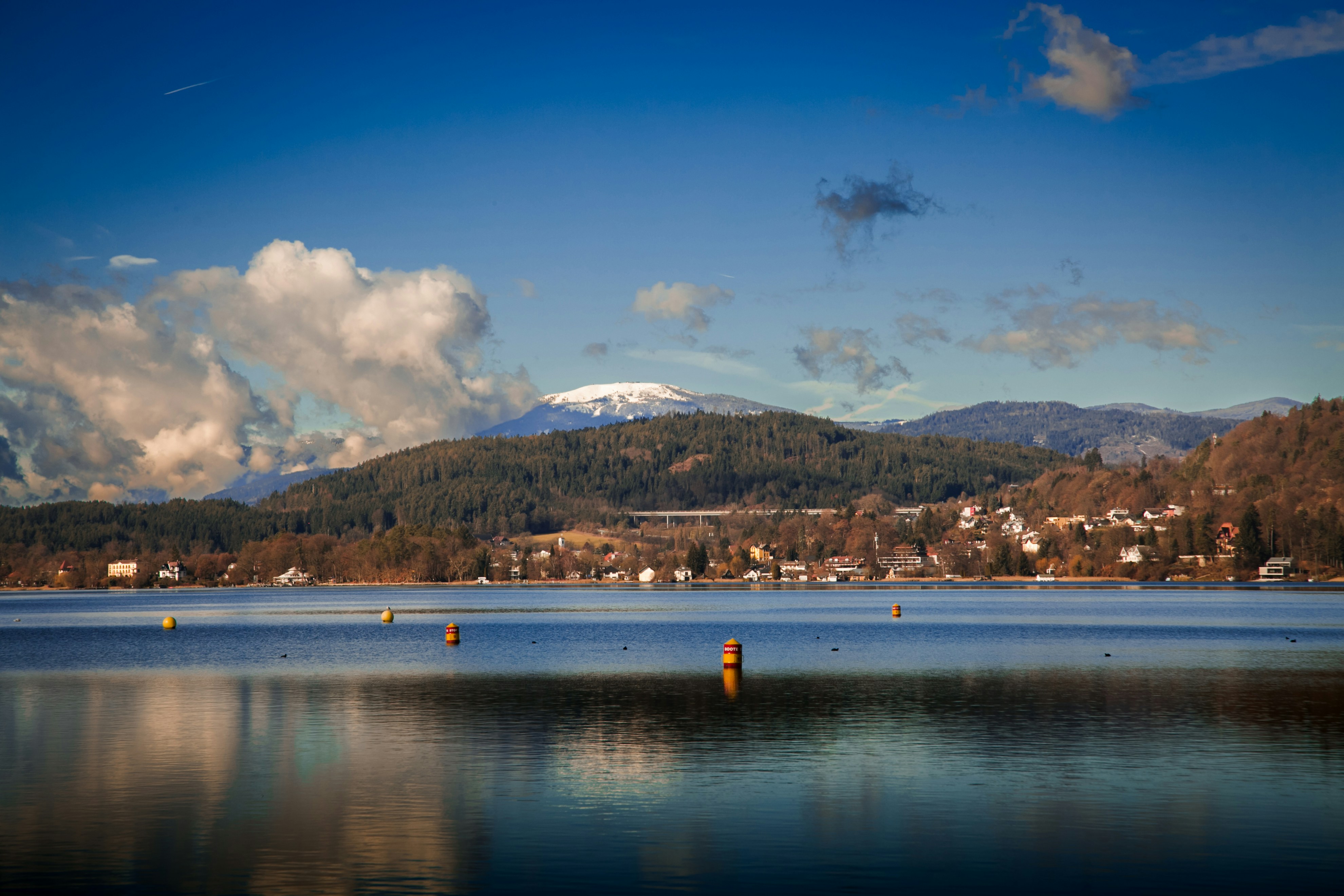 Calm Alpine Lake Reflecting a Snow-Capped Summit