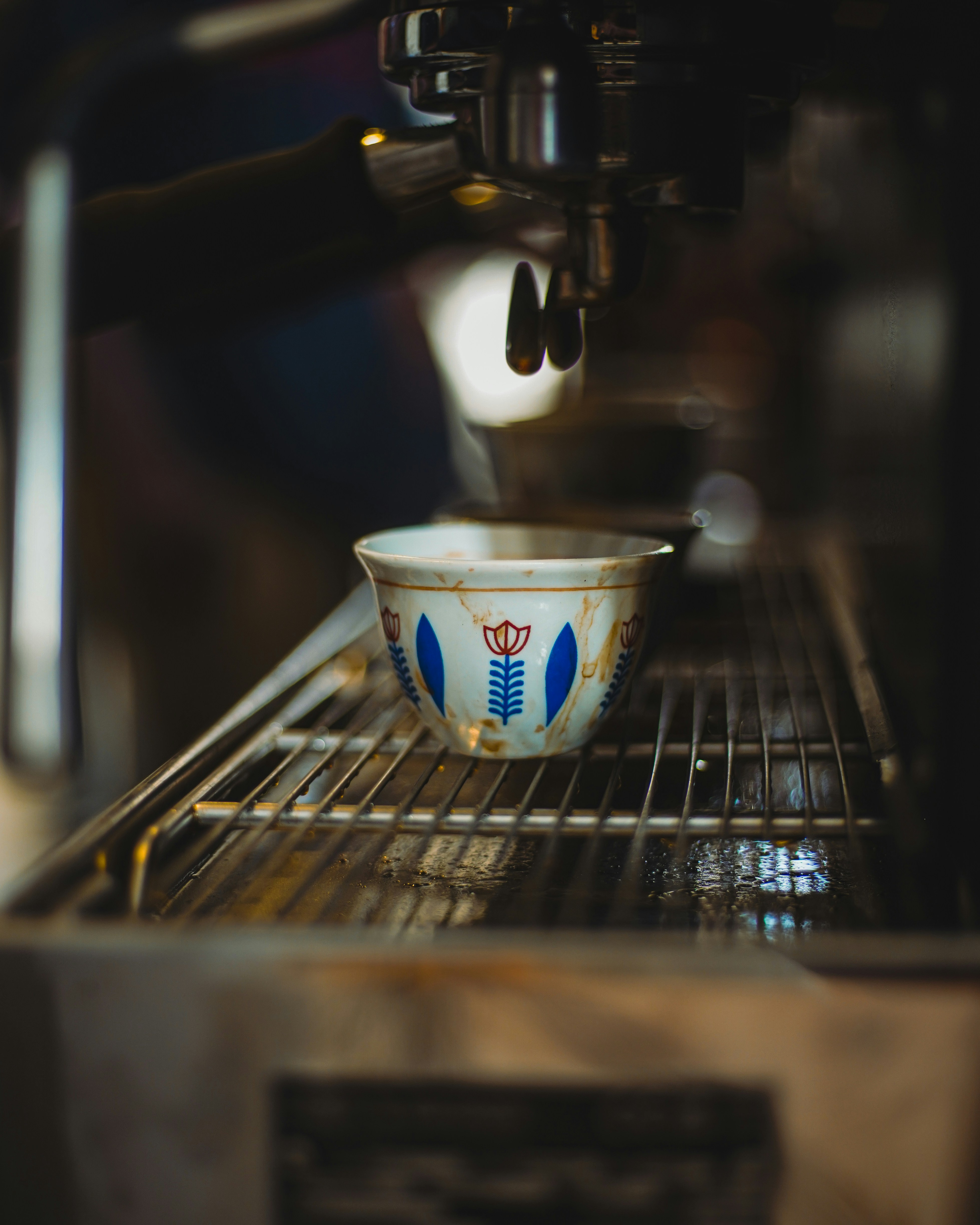 Steam-and-Blue: A Ceramic Cup Emerges Under Espresso Glow