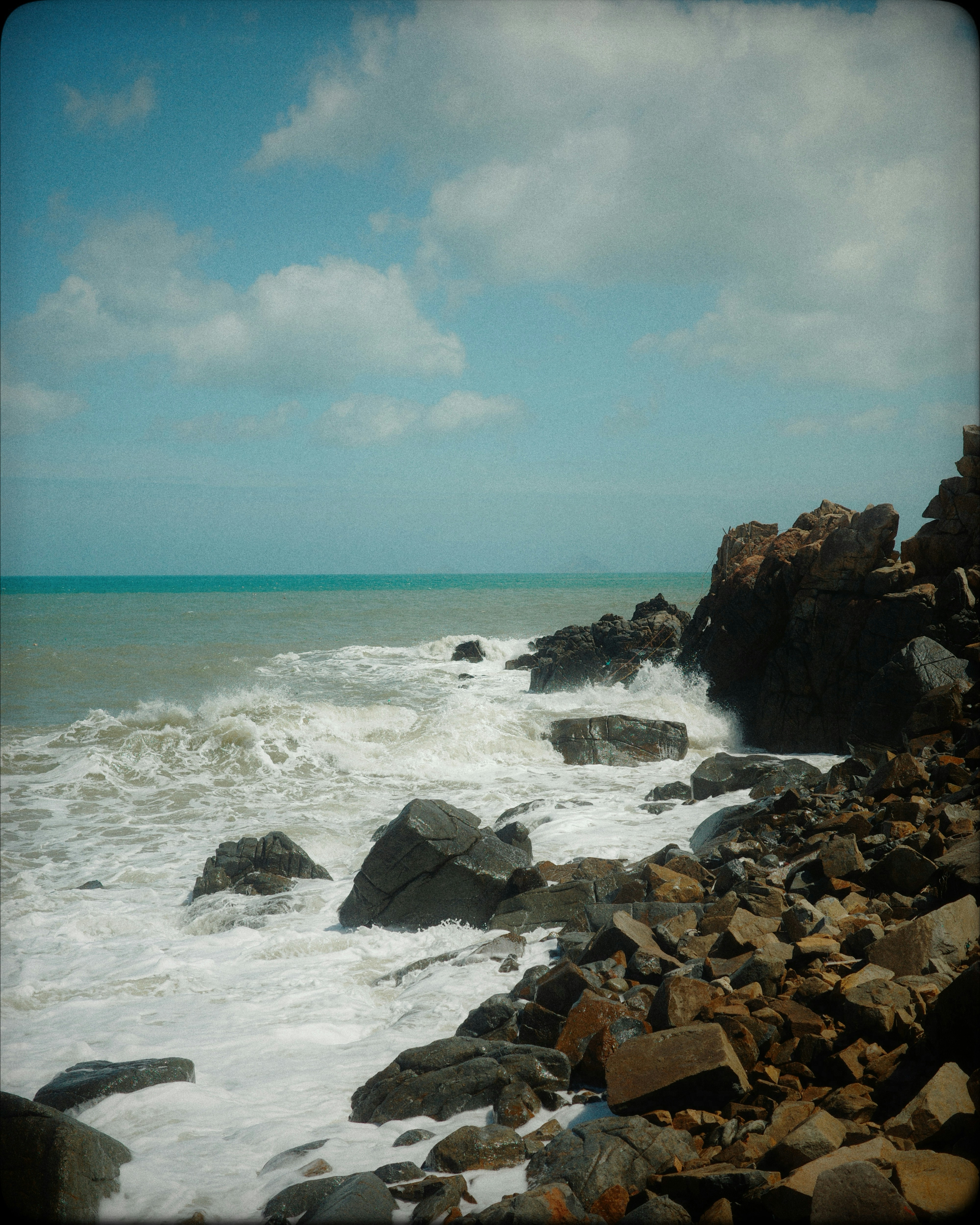 Rugged Shoreline: Breakers Meet the Jagged Rocks