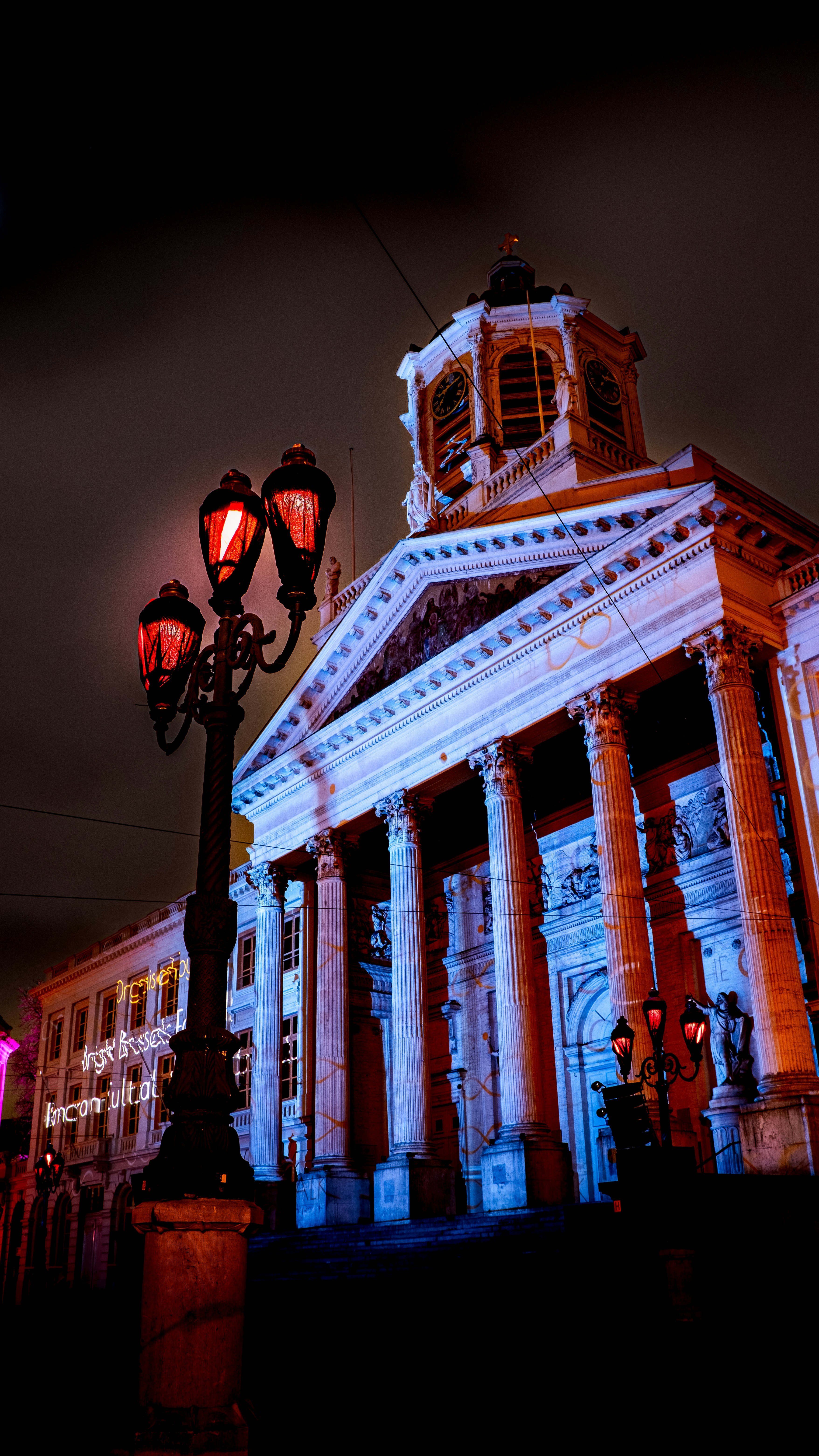 Neon-tinged Facade: A Historic Courthouse Bathed in Nightlight
