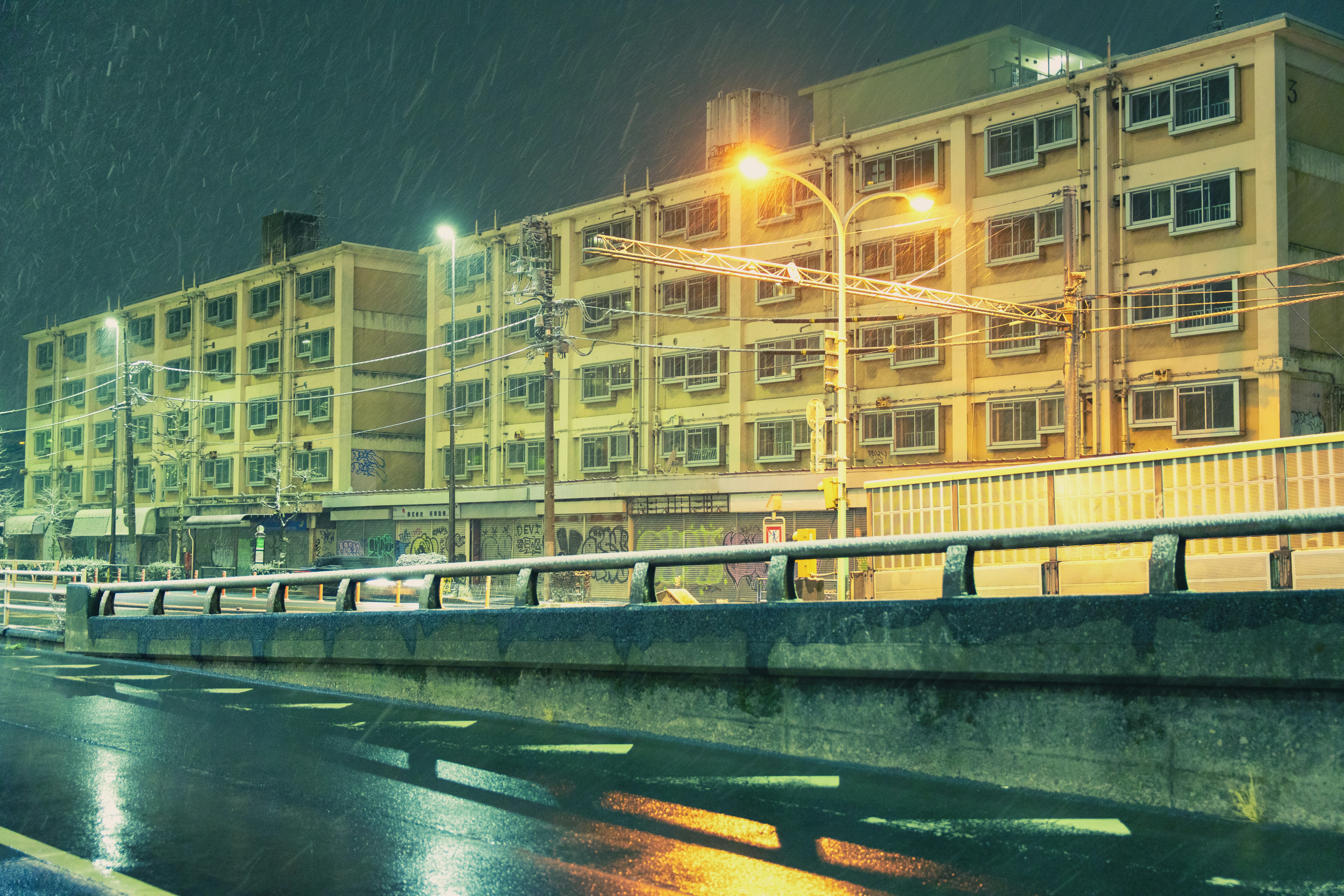 Rain-slicked Urban Light: Night City Block Under Neon Snow