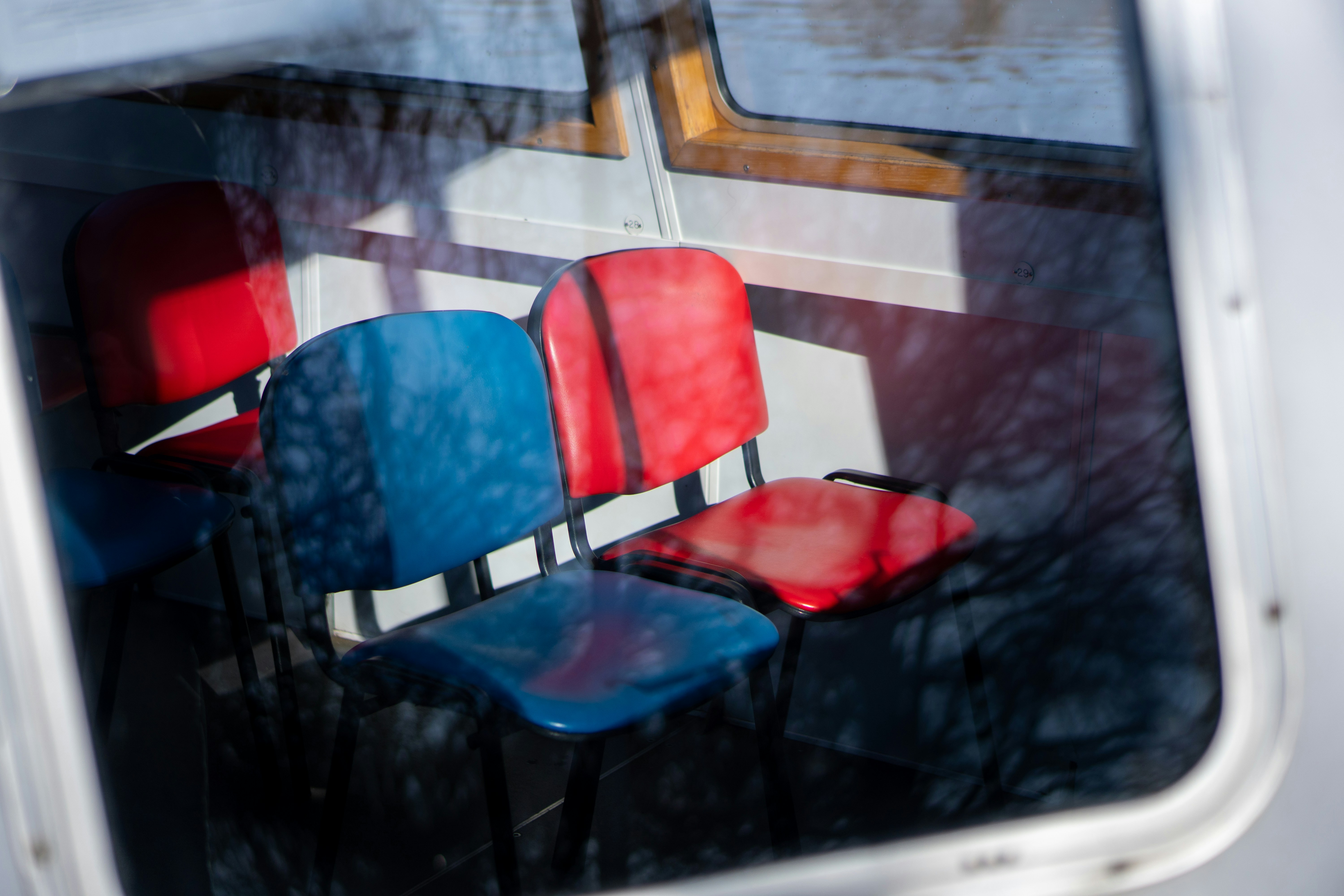 Colorful Seats Reflected in a Bus Window