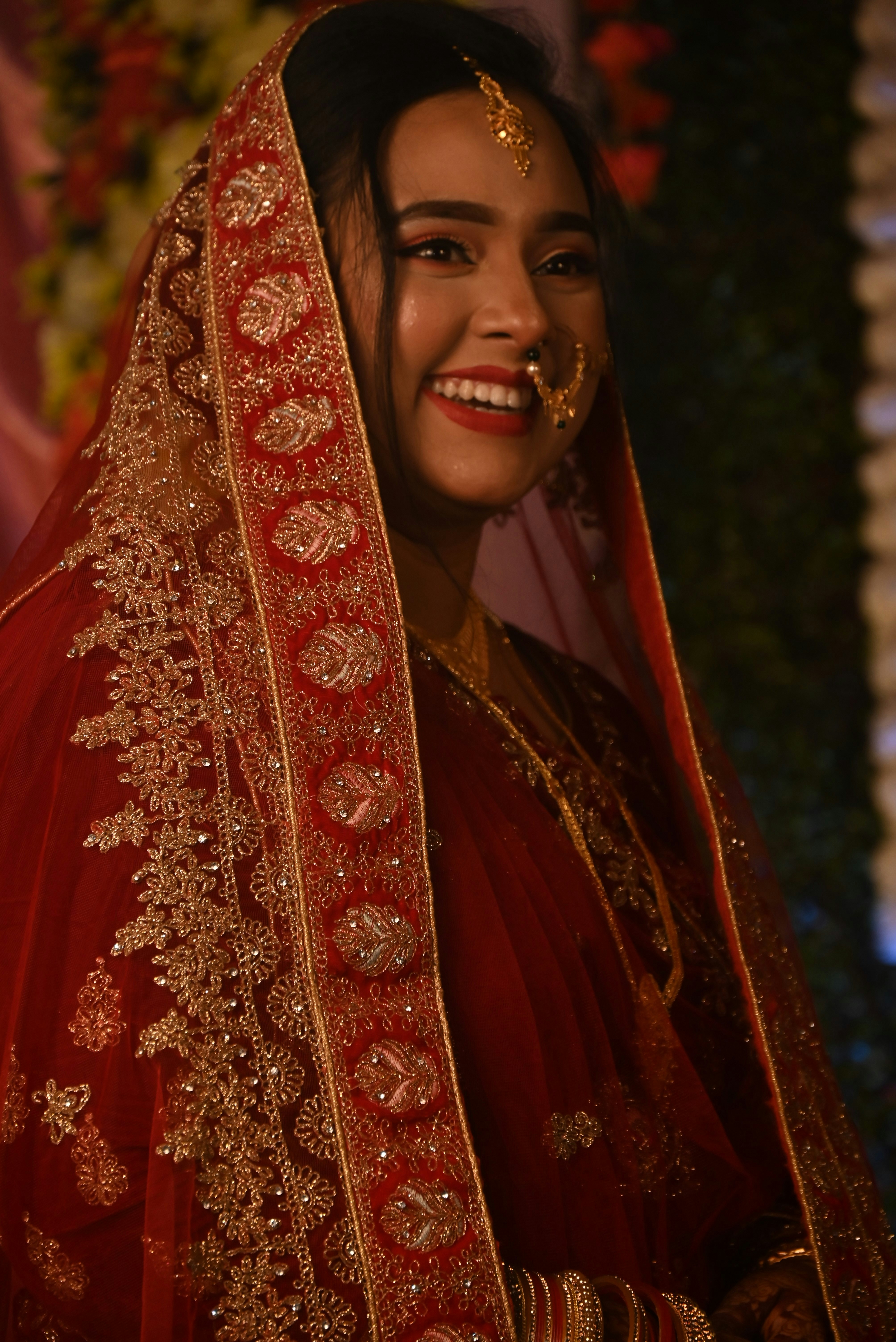 Joyful Bride in Gold and Crimson Veil