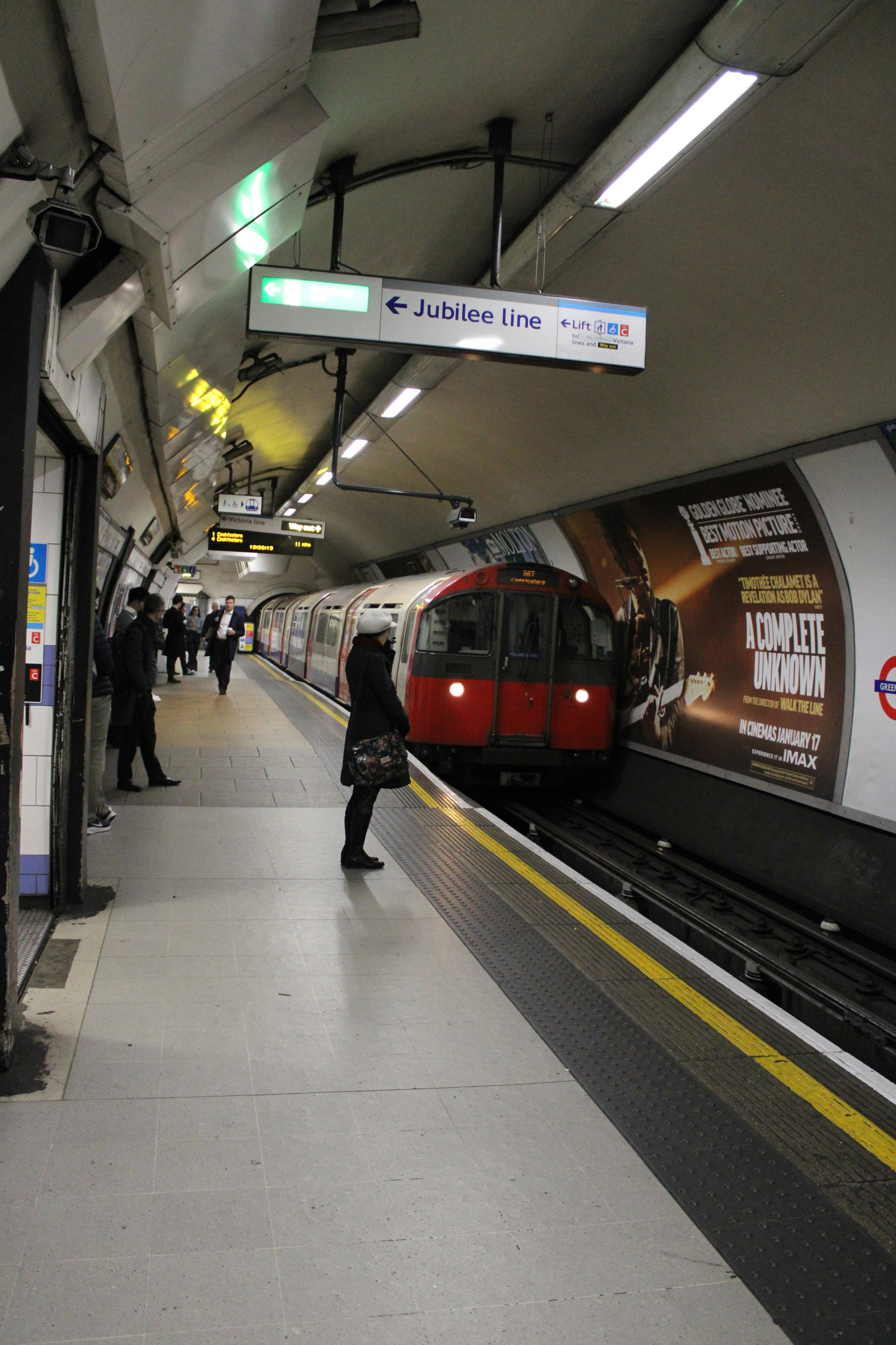Platform Edge Echo: Commuter Pause by the Red Train
