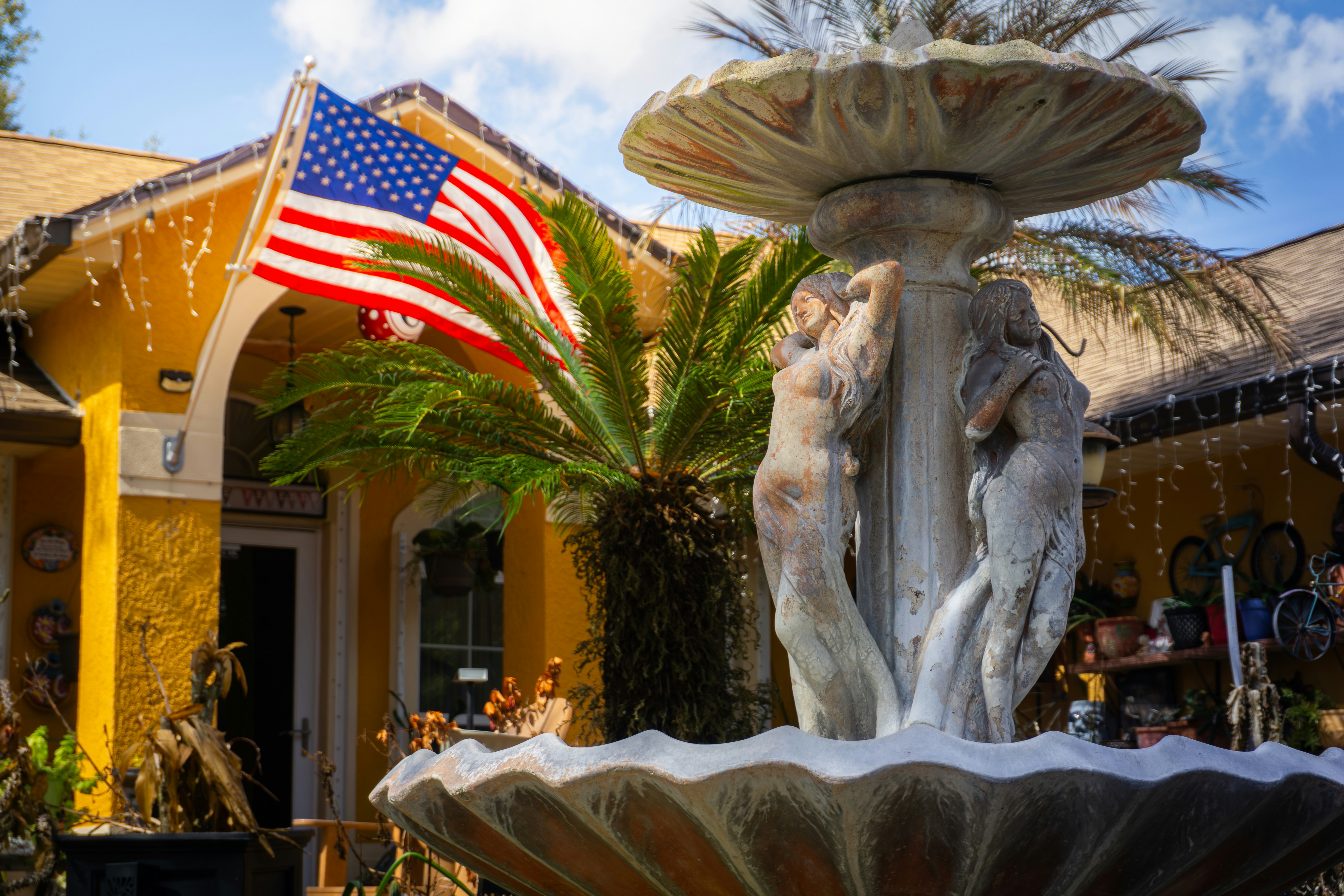Sunny Courtyard Fountained Portrait with Flag and Palm
