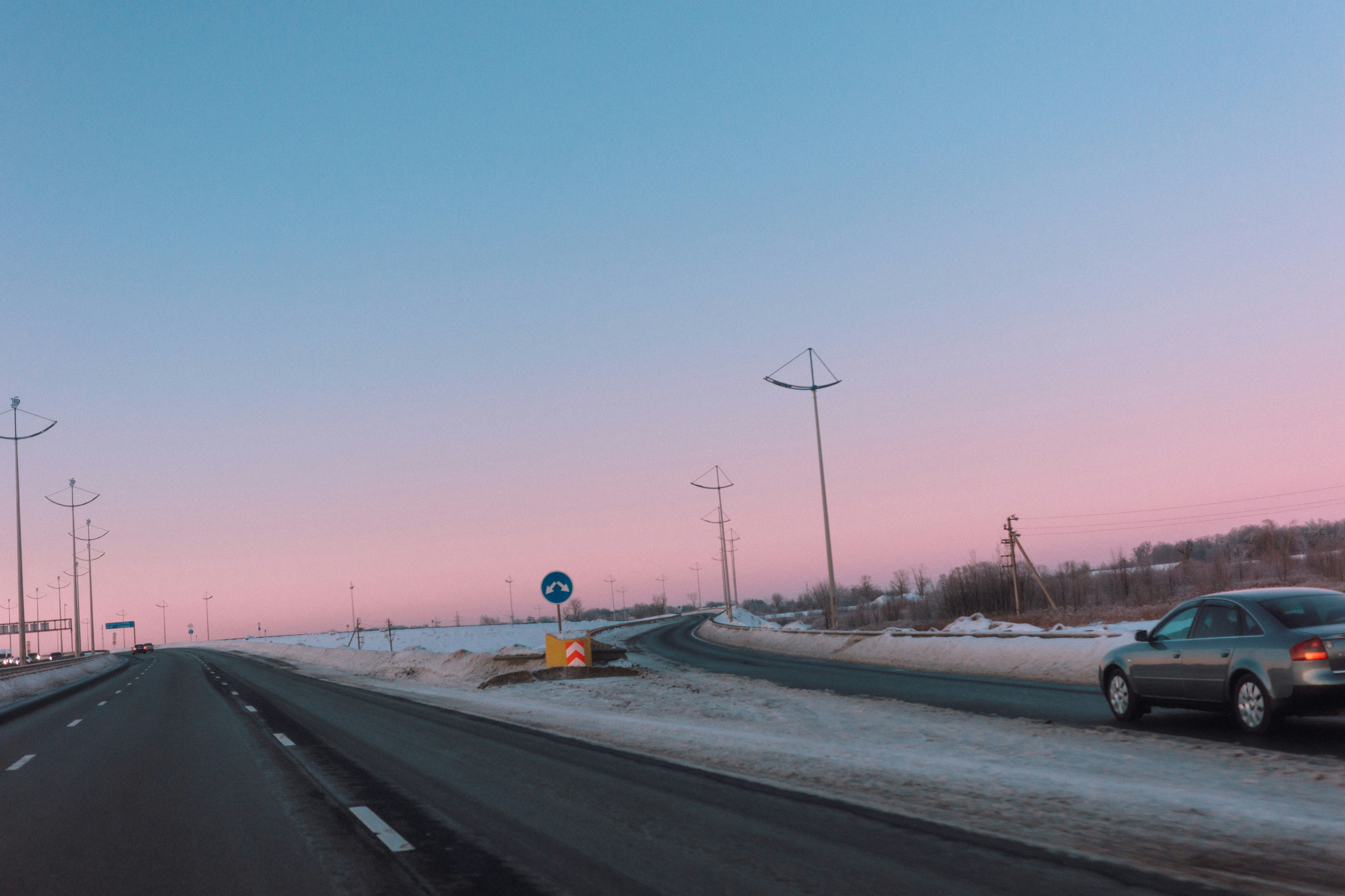 Pastel Sky Over Snow-Patched Highway