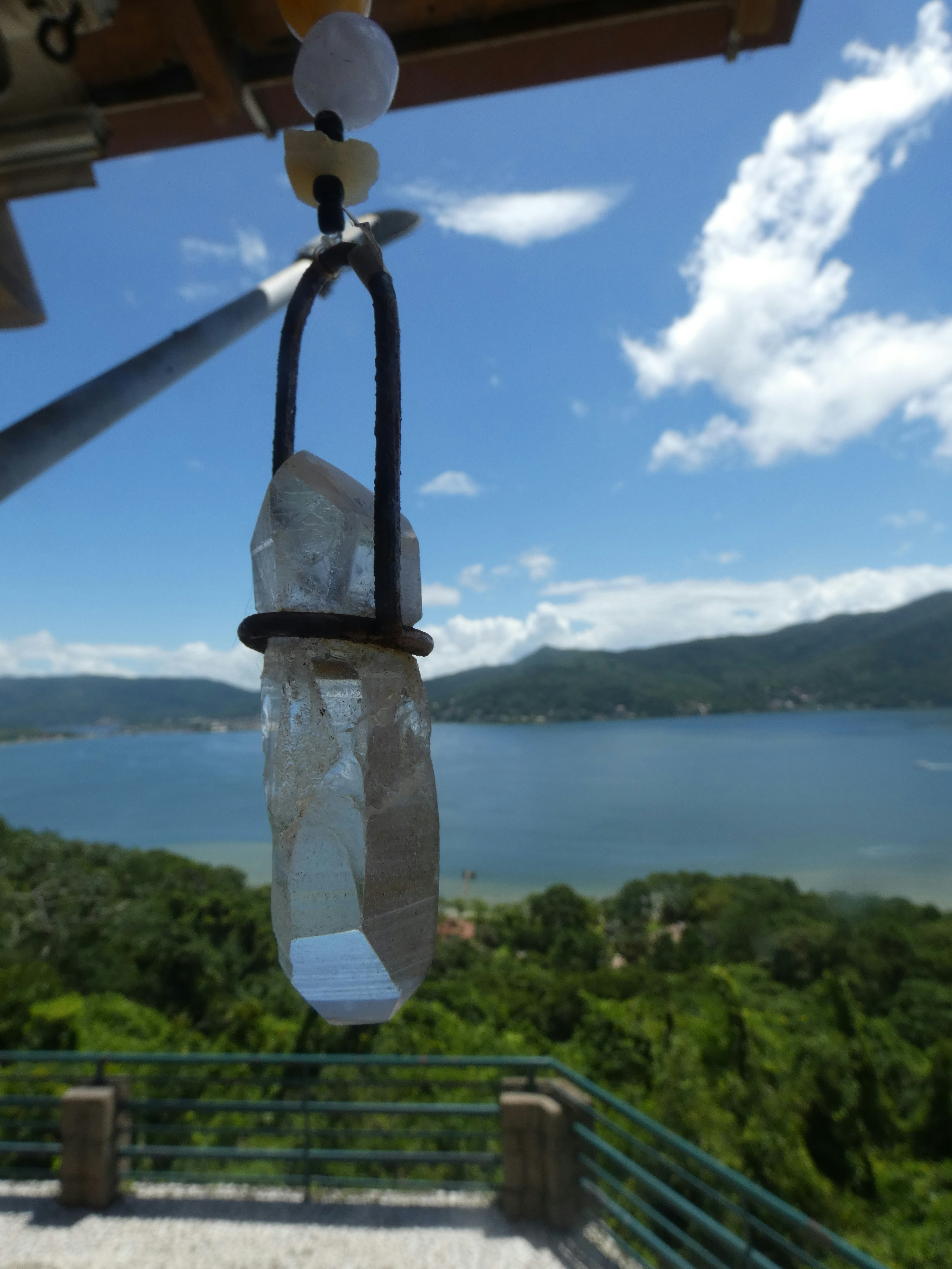 Crystal pendant over a tranquil lake vista
