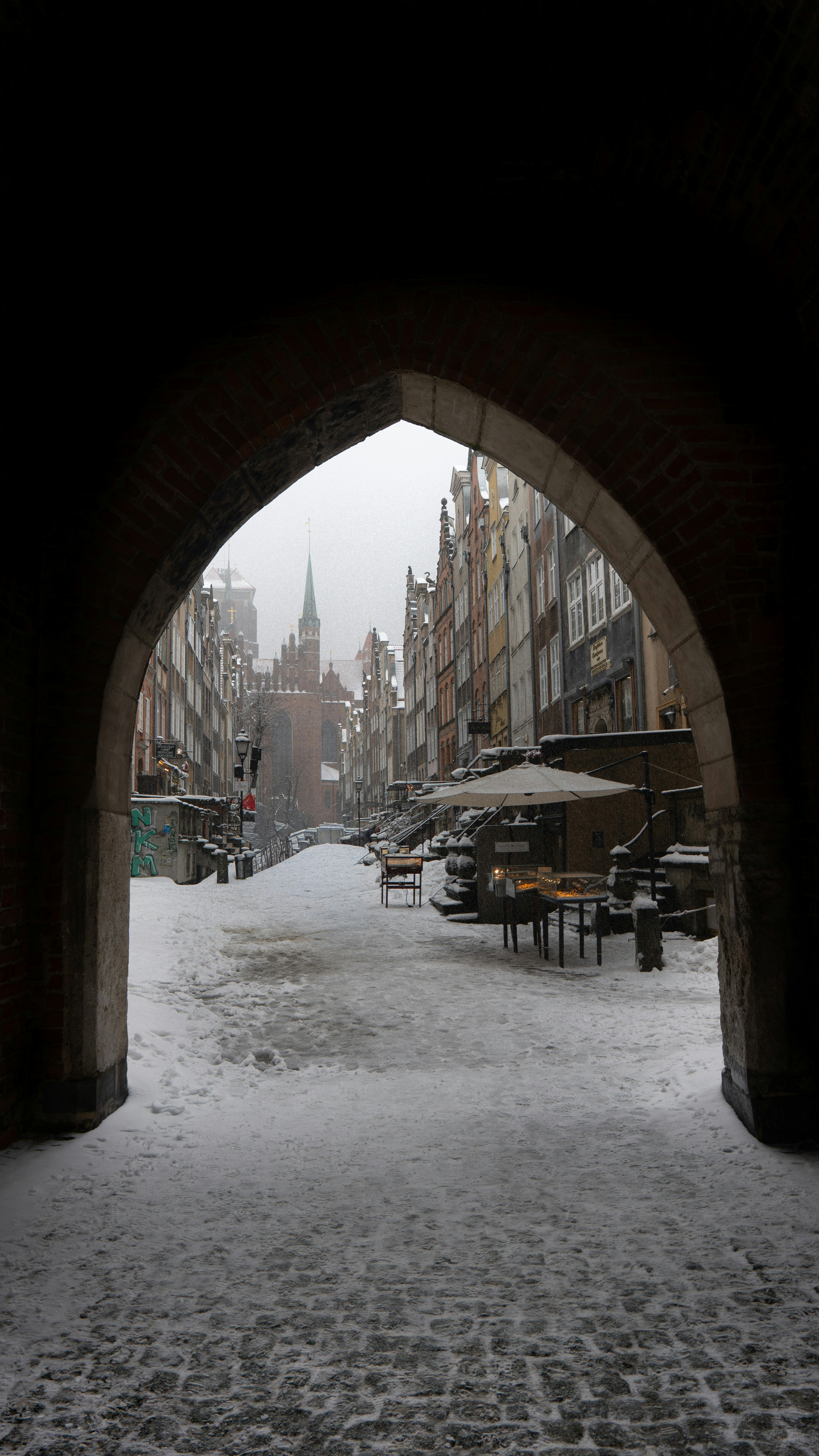 Snowy Arc: A Cathedral Arch Framing a Quiet Street