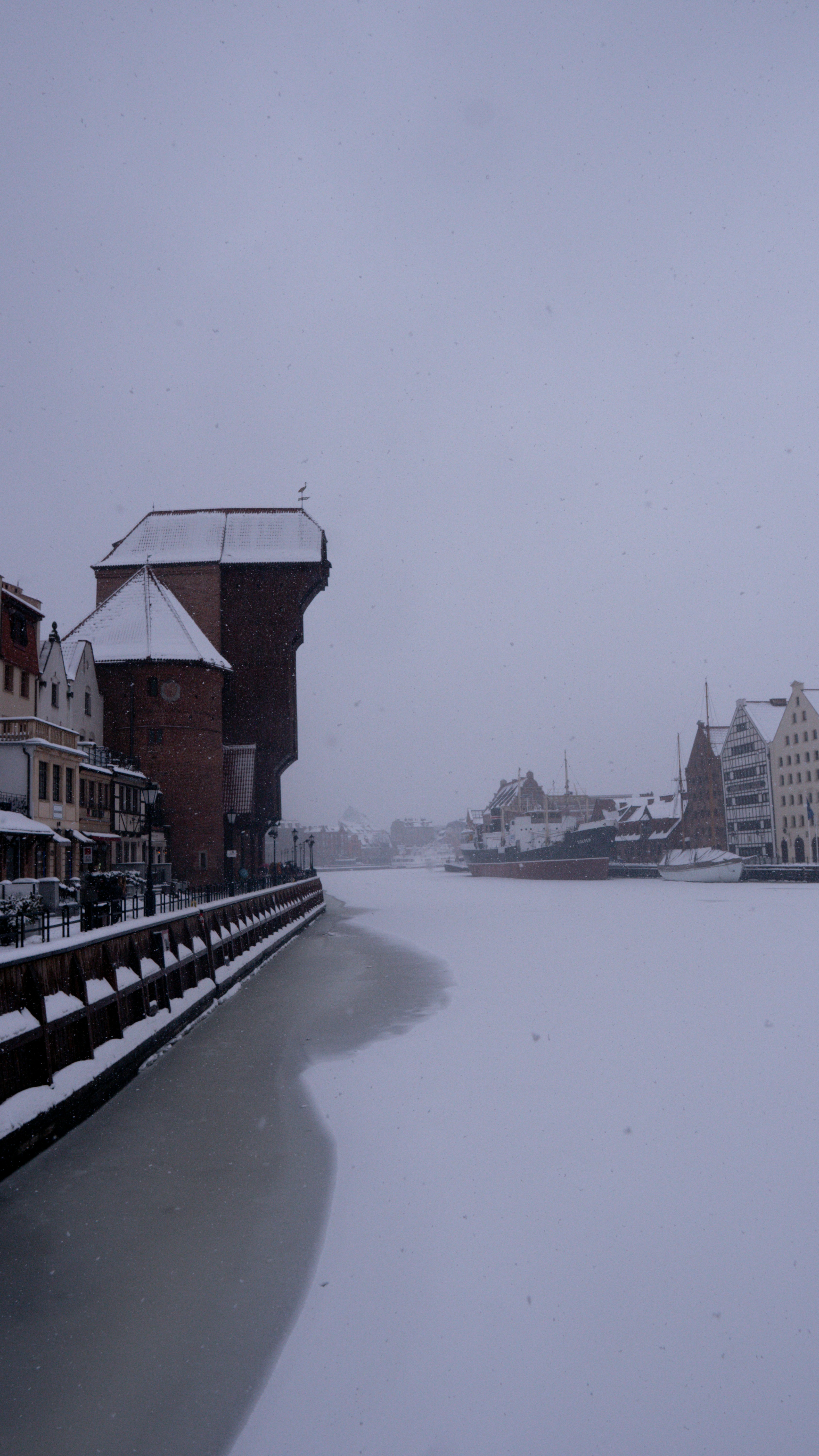 Snowbound Canal: Historic Wharfed Town Under Quiet Skies