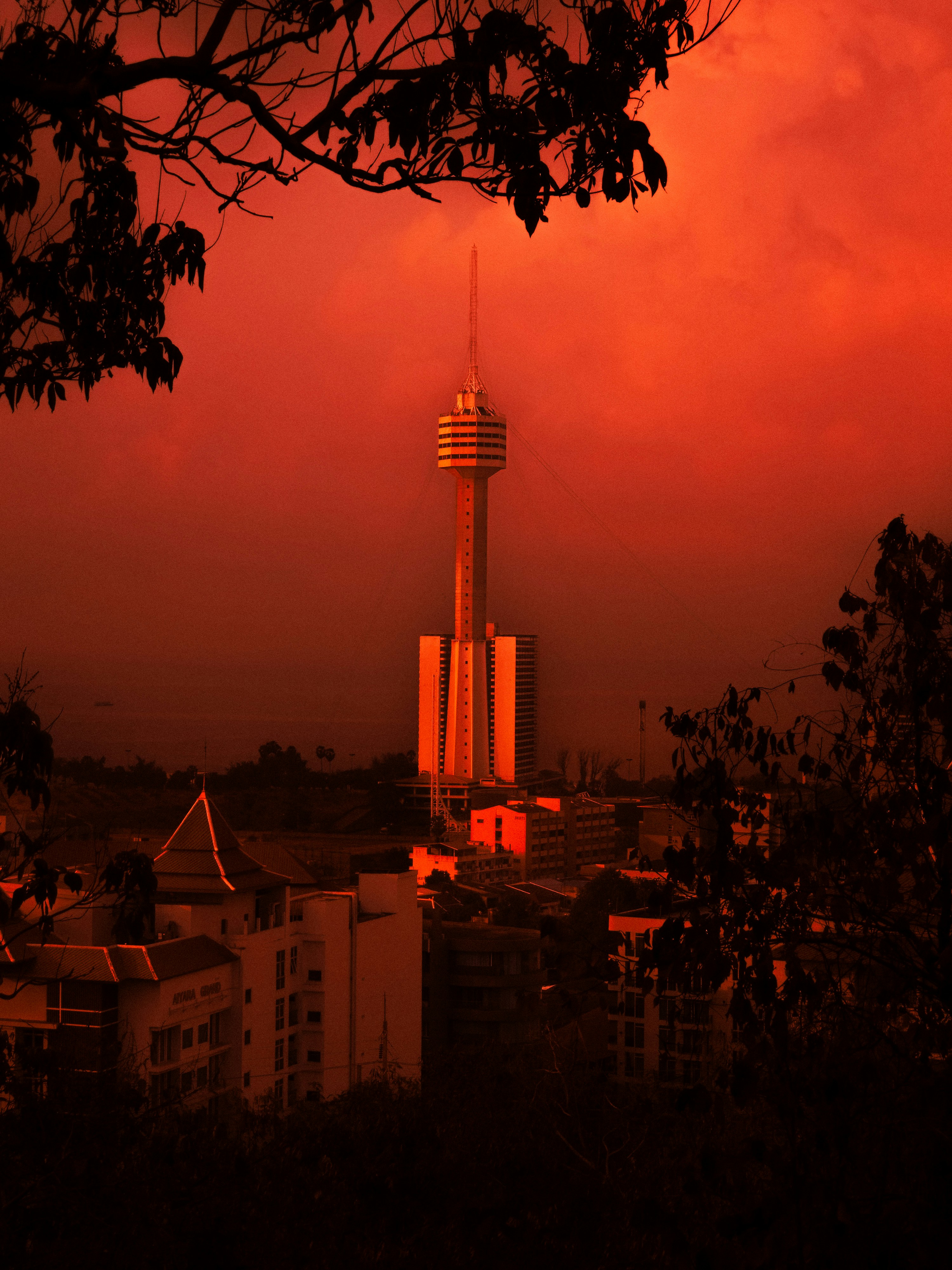 Tall tower against a dramatic red sky at sunset