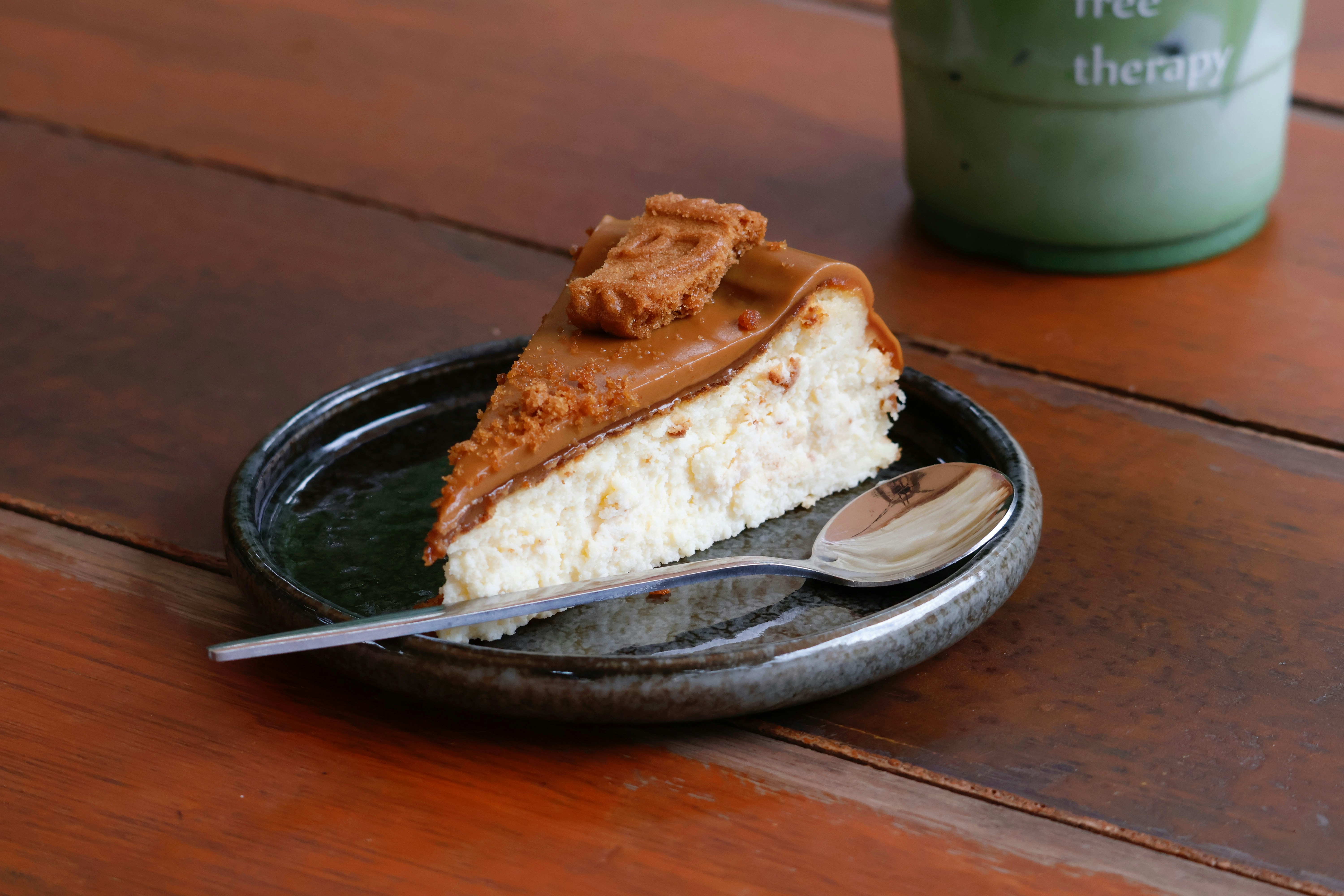 Slice on a Saucer: Caramel Topped Cheesecake Resting on a Rustic Plate
