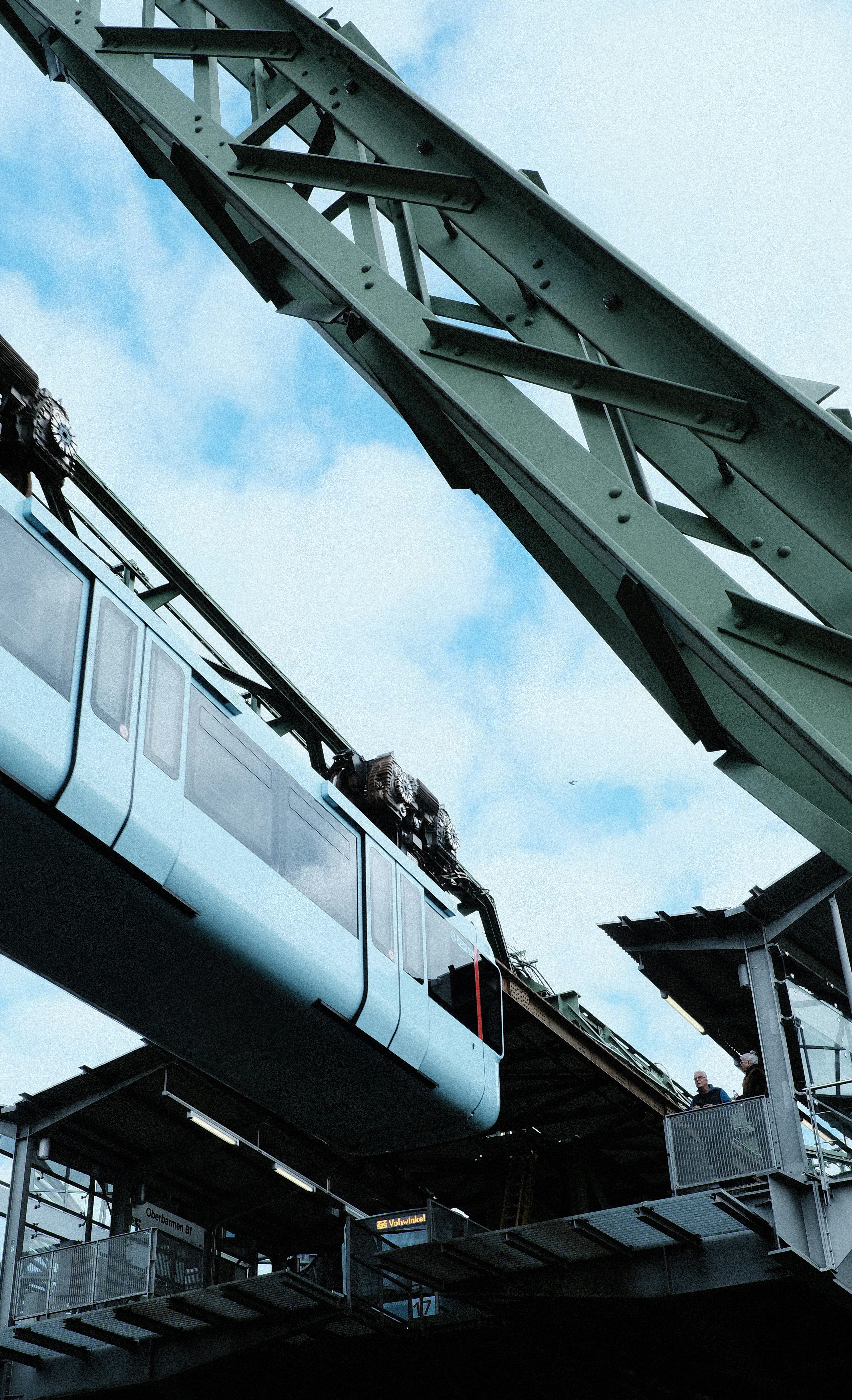 Rising Steel: A Truss Bridge Looms Over a Modern Transit Car