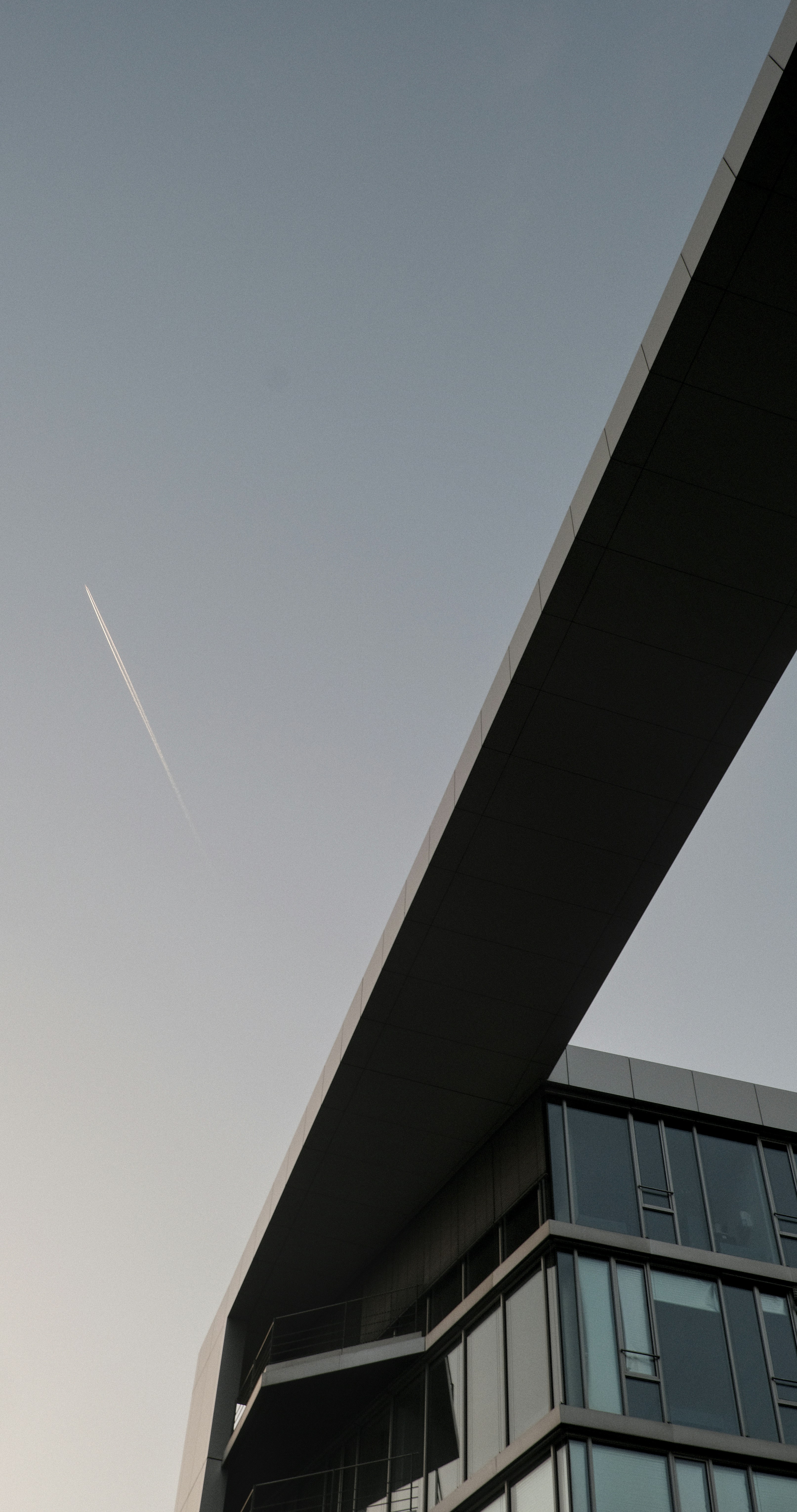Angular Confluence: Skyward Rails Skimming a Modern Facade