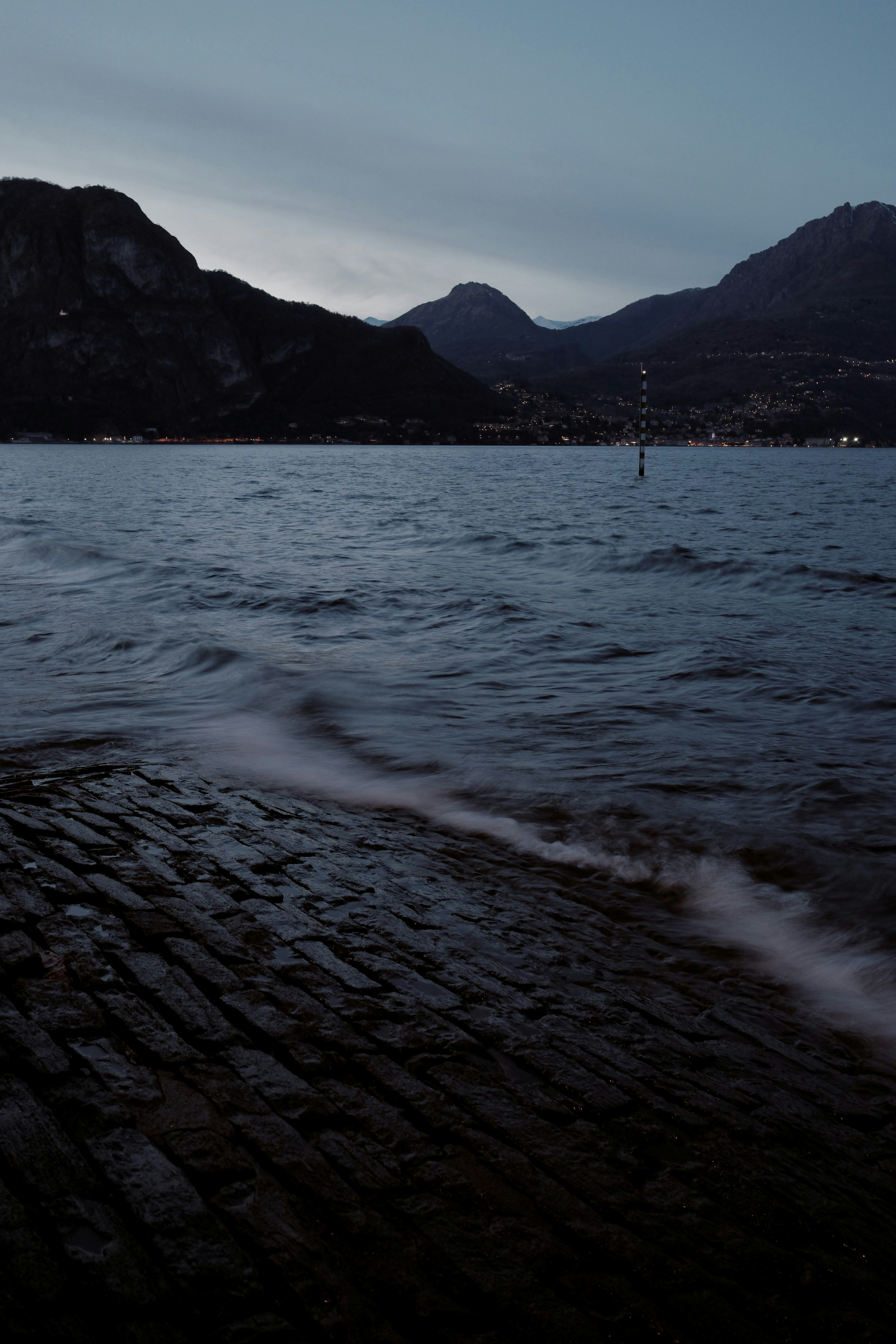 Dusk Over the Darkened Fjord: Waves Against a Quiet Shore