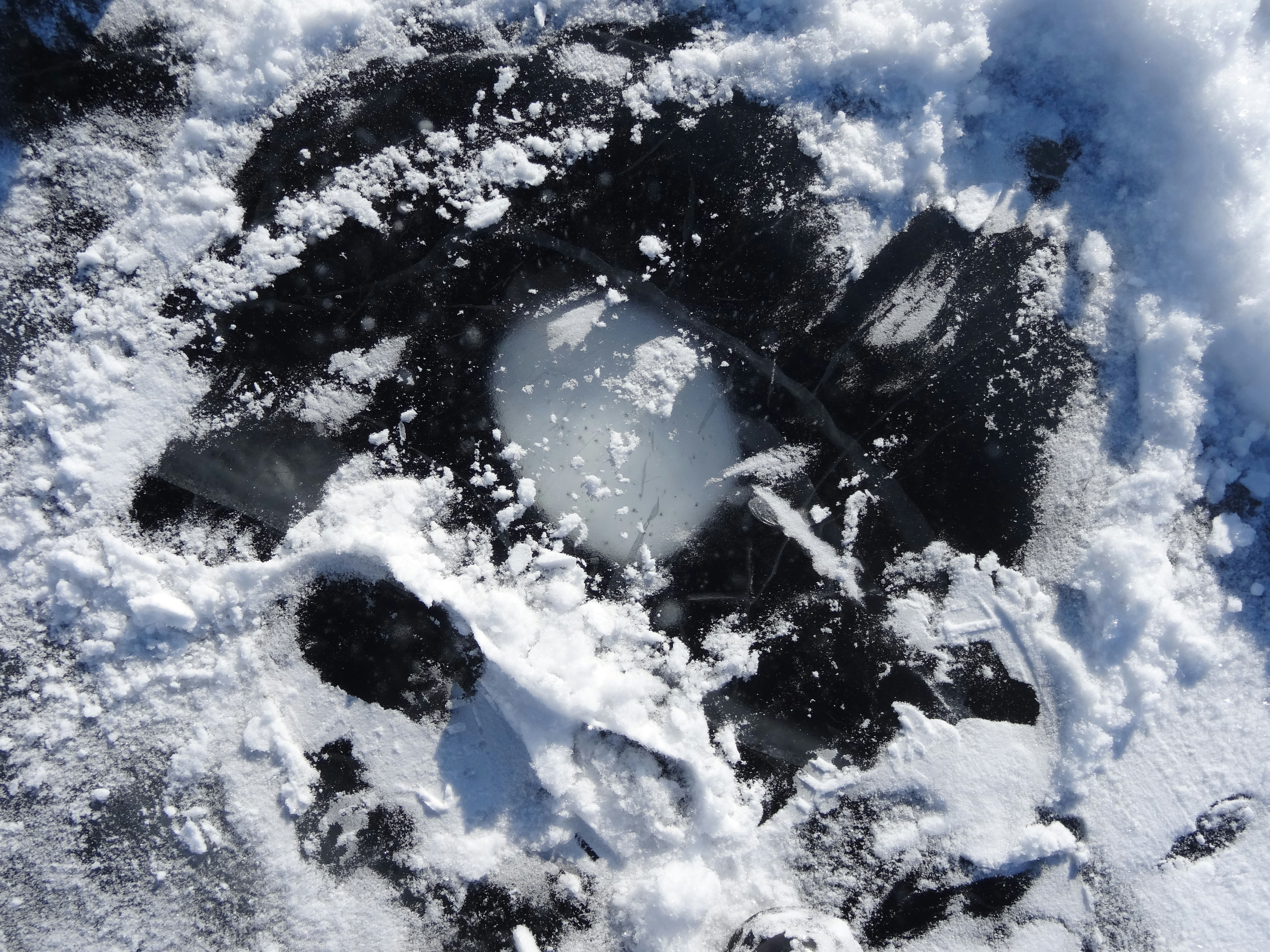 Close-up of cracked ice and snow on a frozen surface.