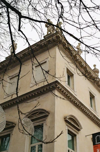 Historic Cornerstone: A Venetian-Style Facade Framed by Leafless Branches