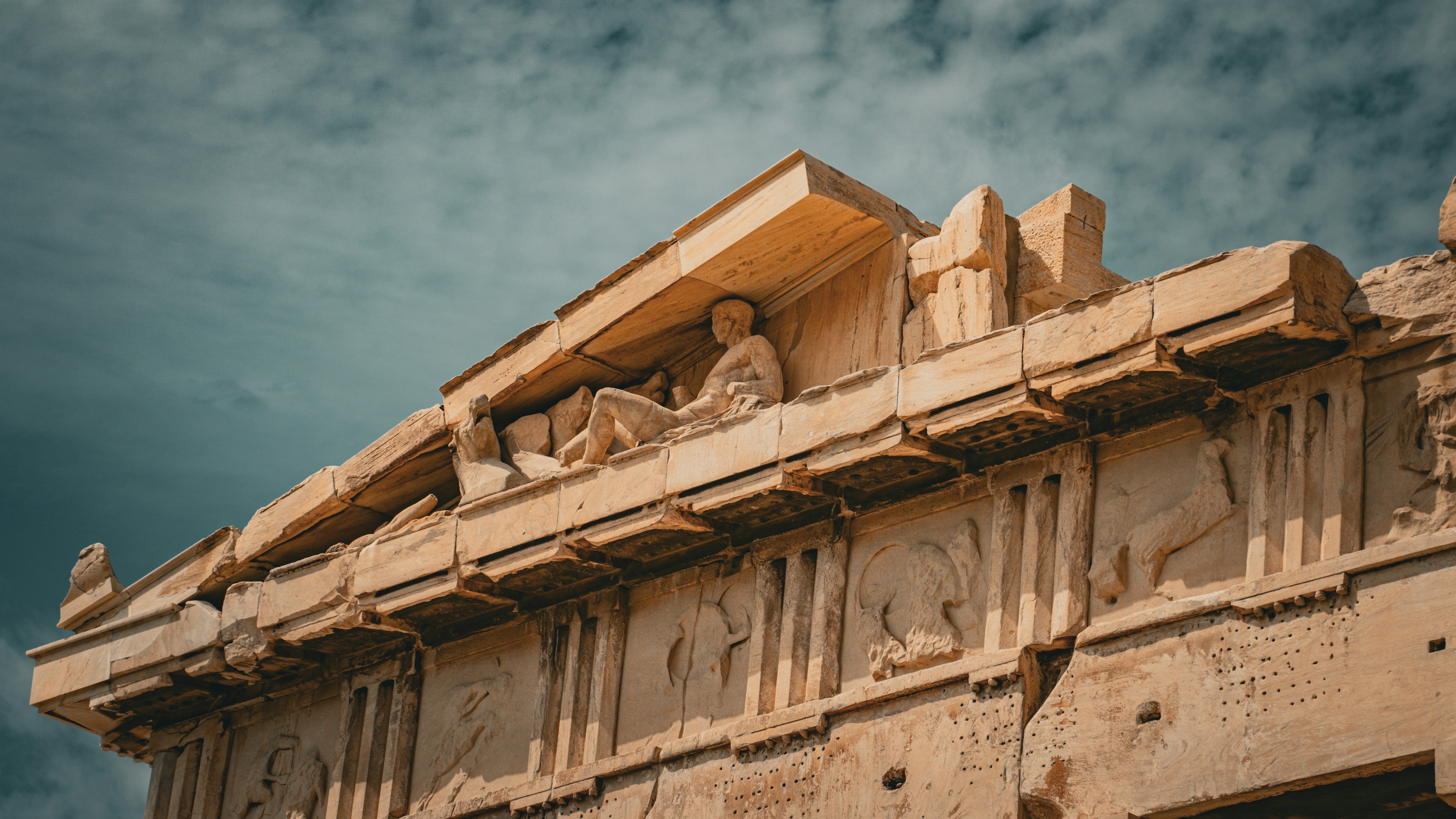 Stone Carved Frieze Under a Weathered Pediment