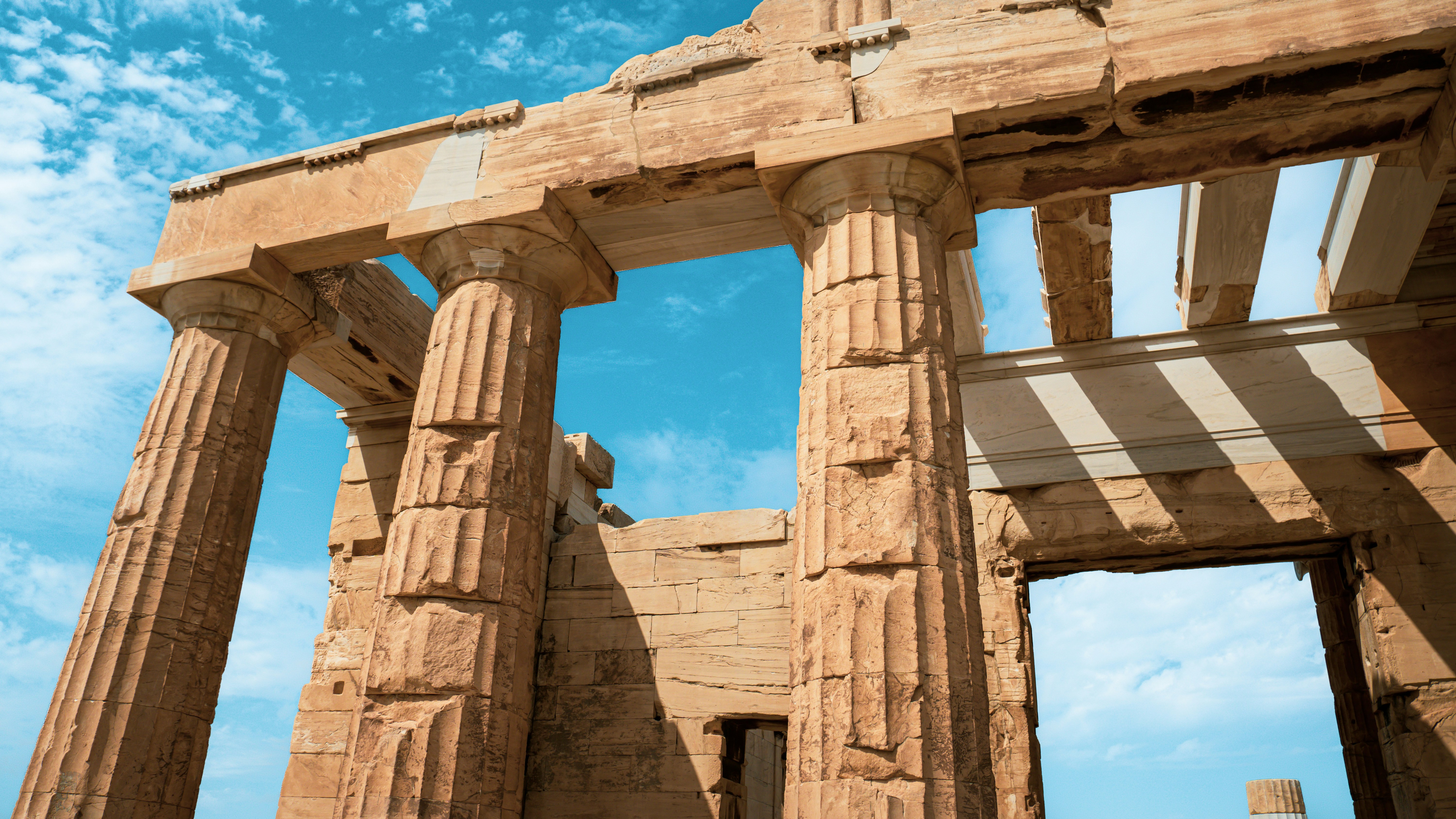 Sunlit Greco-Roman Ruins: Columns Casting Long Shadows