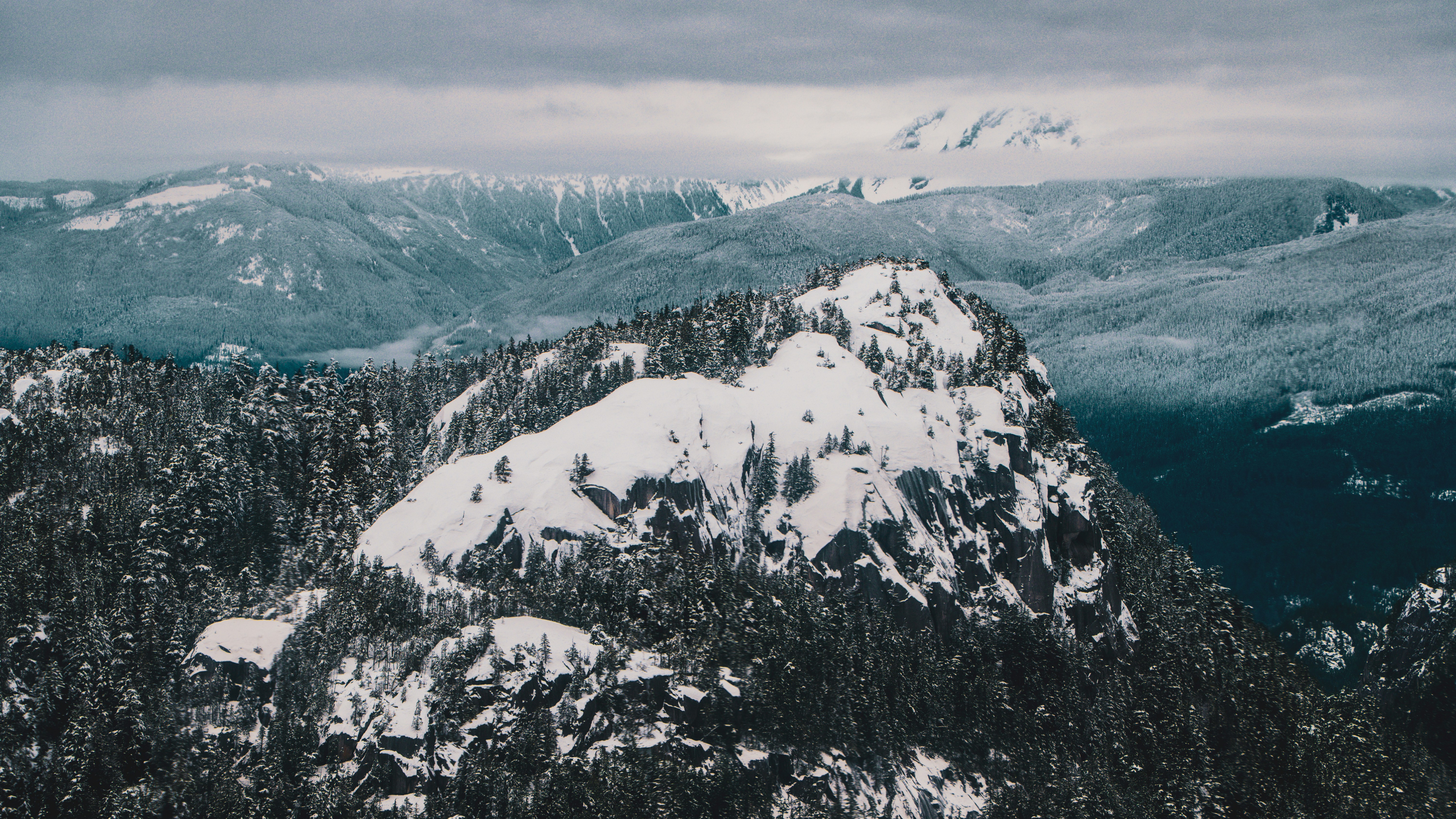 Snowbound Summit: A Quiet Peak Surrounded by Distant Ranges
