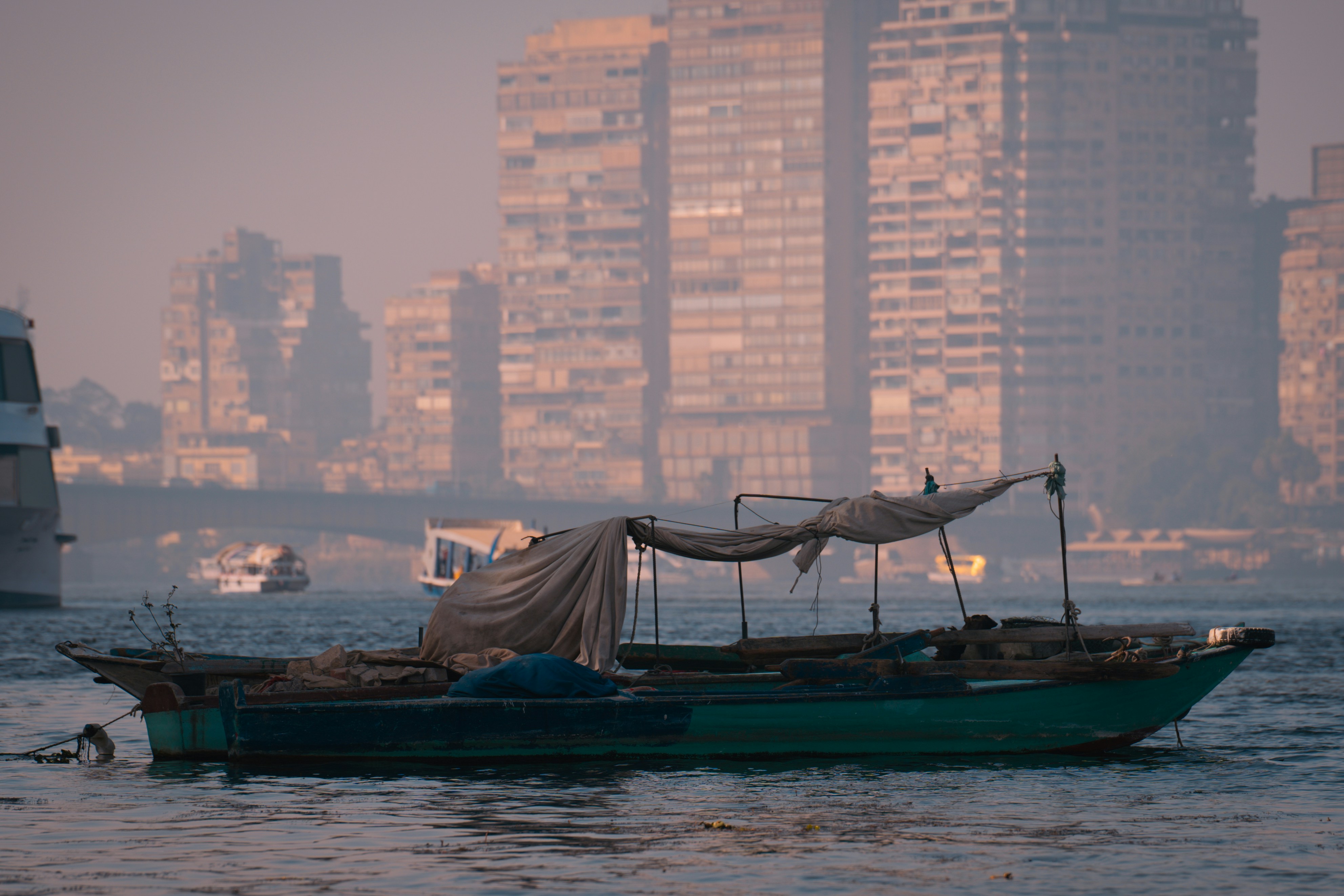 Harbor Vessel at Dusk: A Quiet Passage Between Skyscrapers