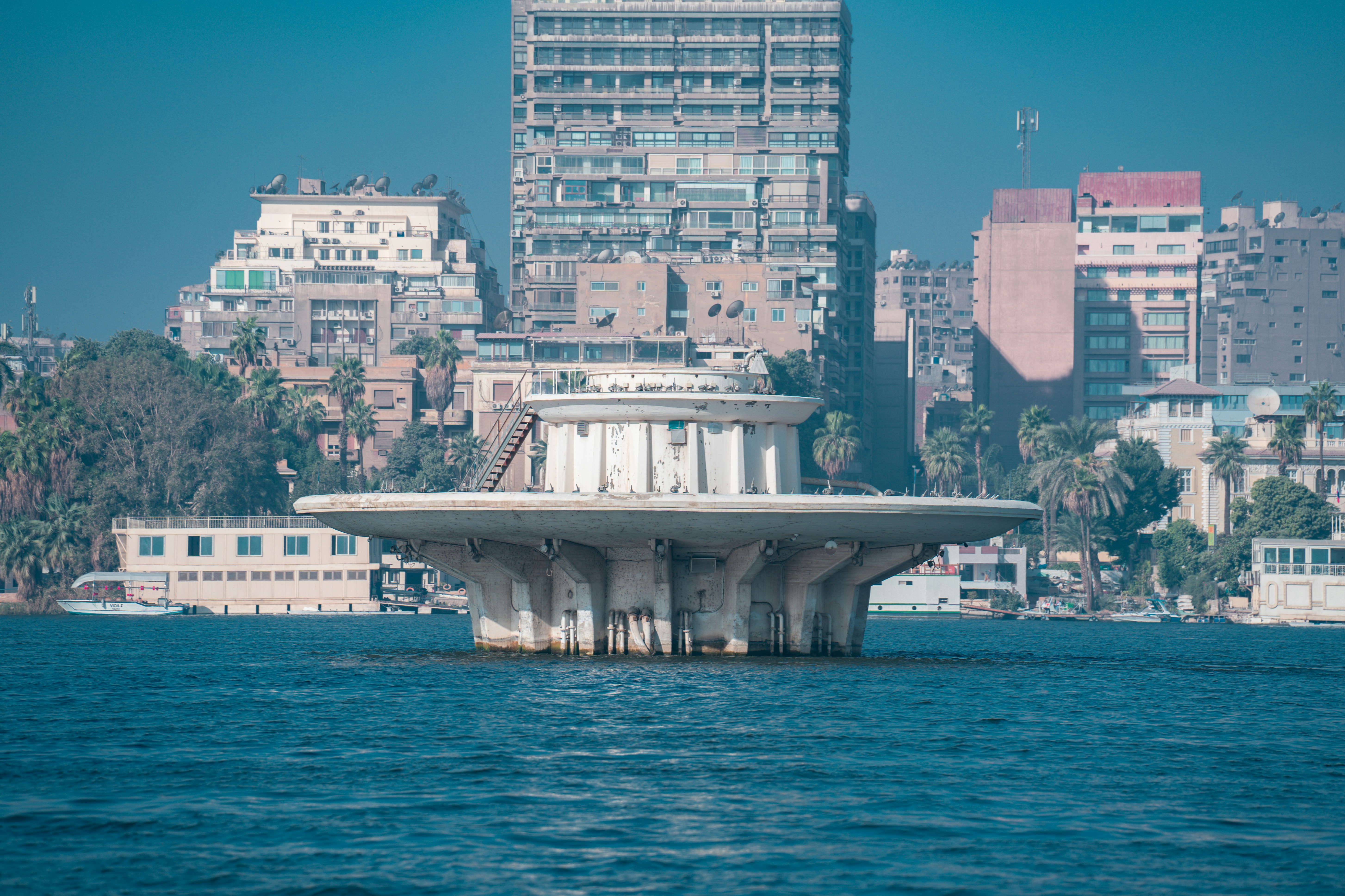 Concrete Circular Pavilion Rising from Harbor Waters