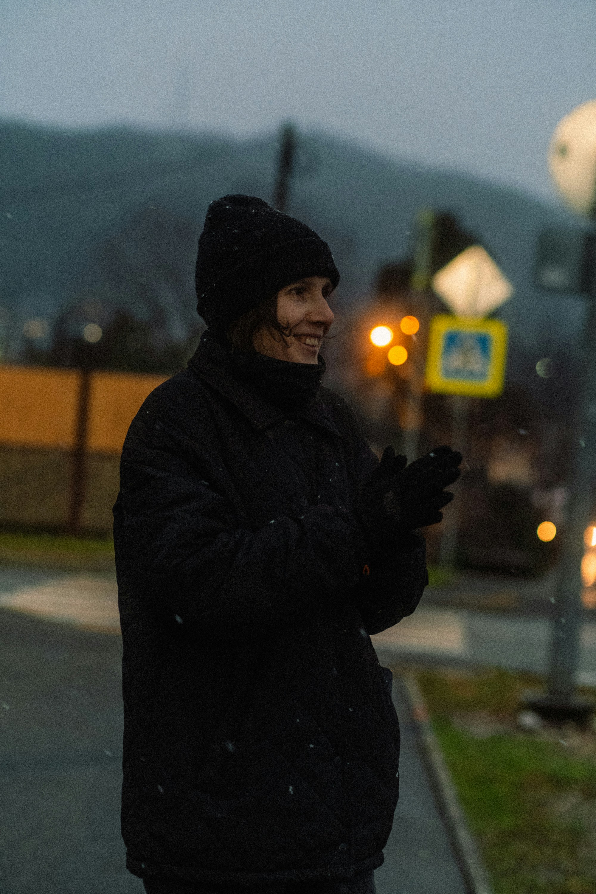 Warm Smile in a Cold Evening: A Clad Figure in Winter Street