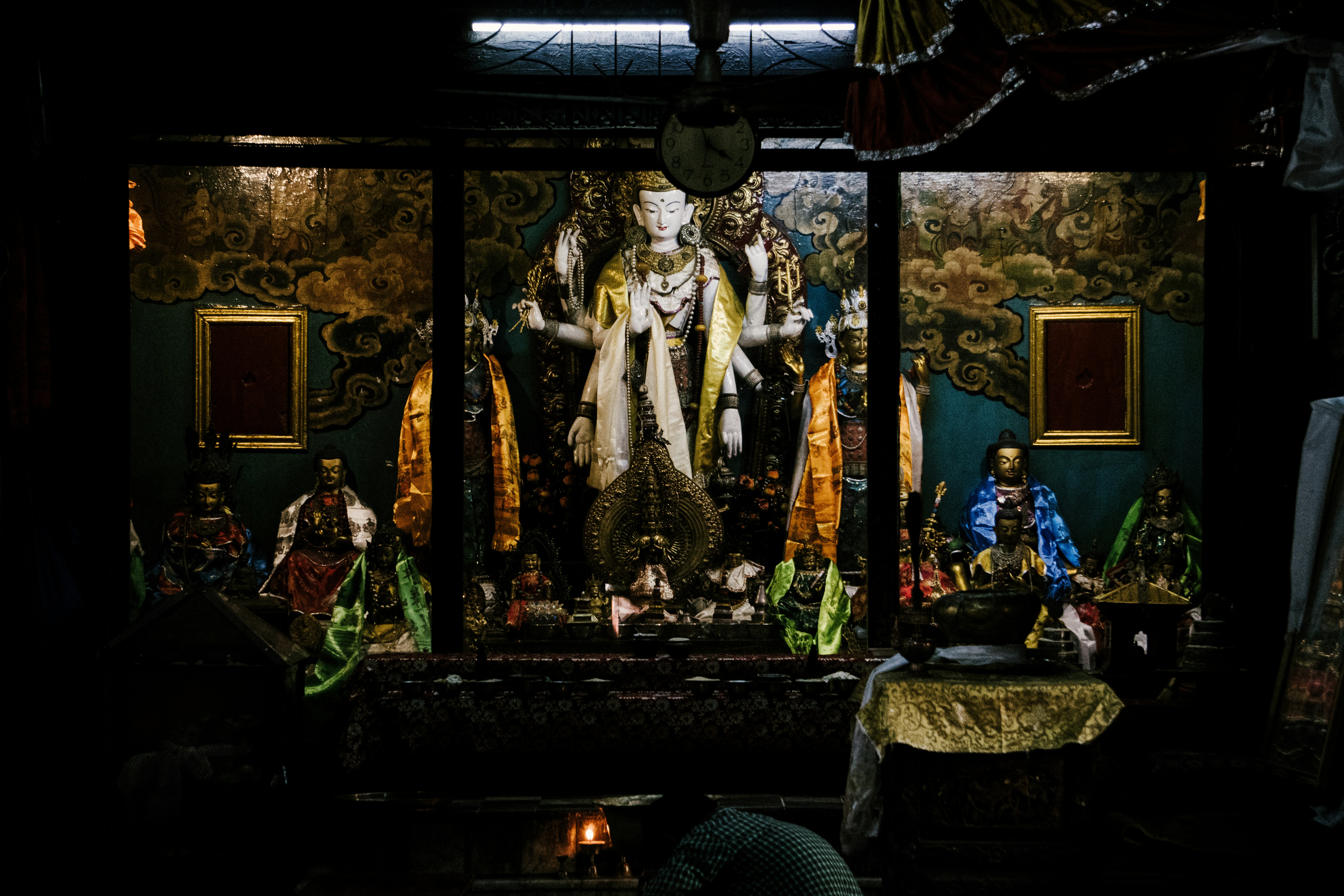 Dim Altar of Colorful Deities in a Sacred Shrine