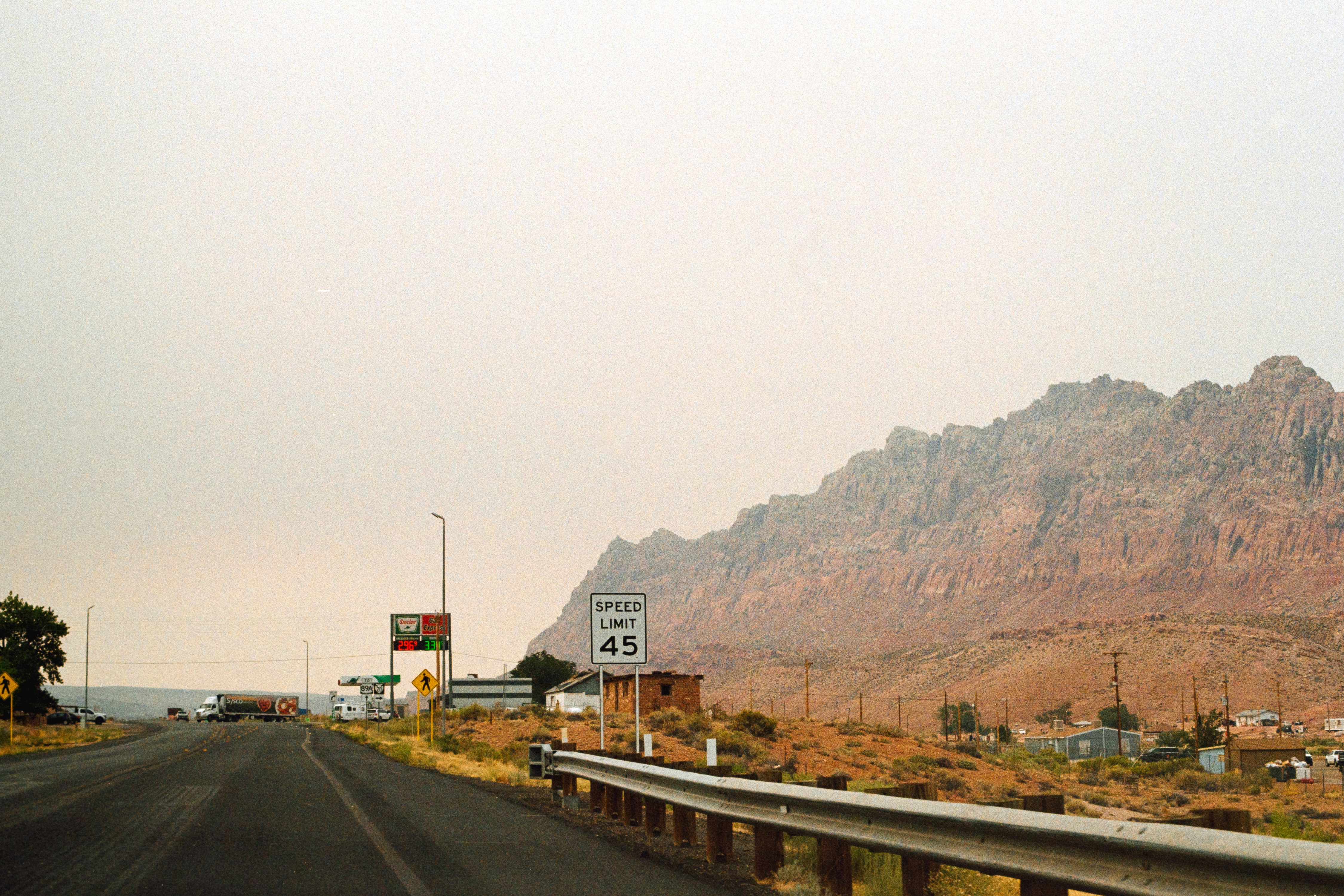 Desert Highway with Rocky Horizon and Distant Traffic