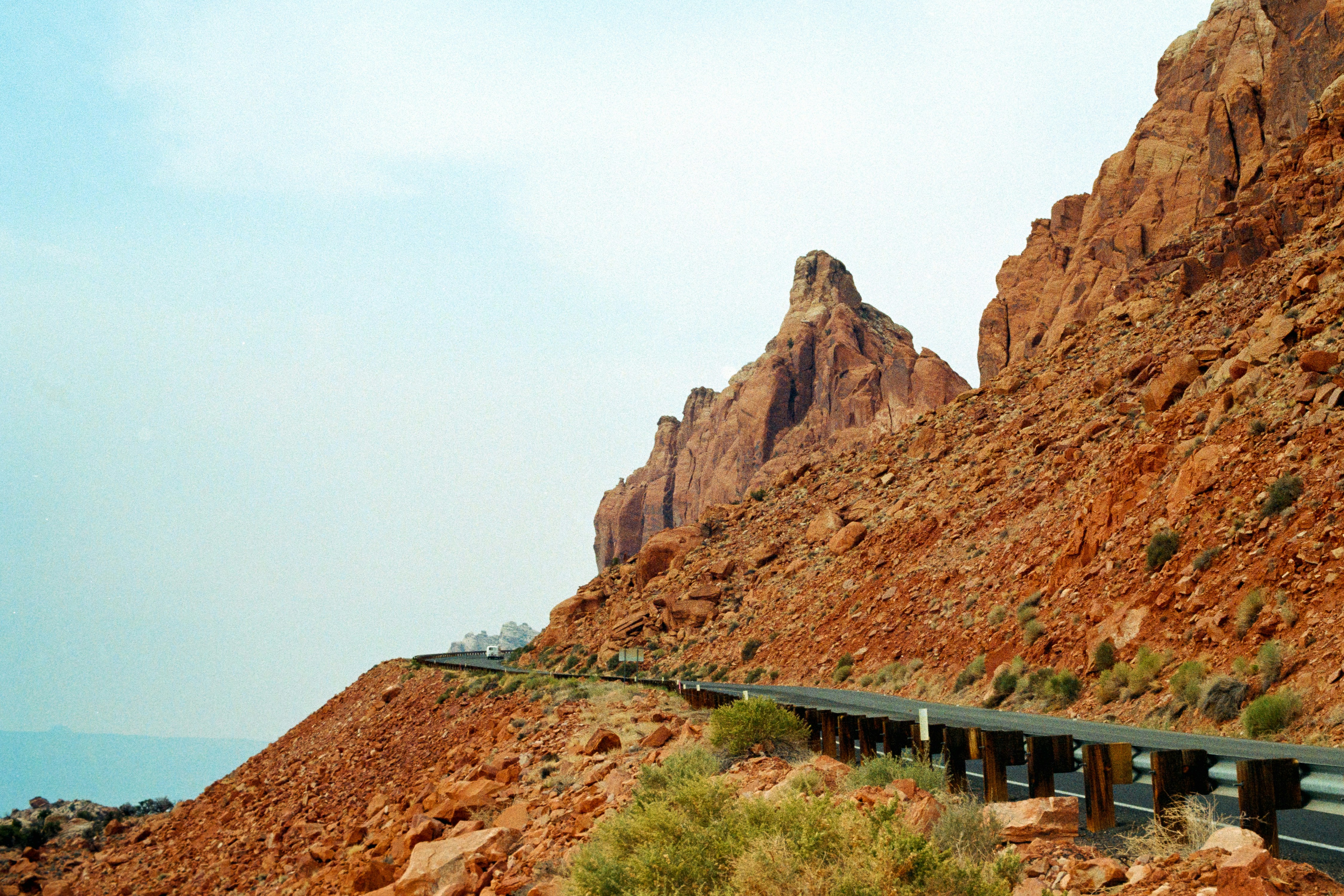Rugged Coastal Road Snaking Beneath Crimson Cliff