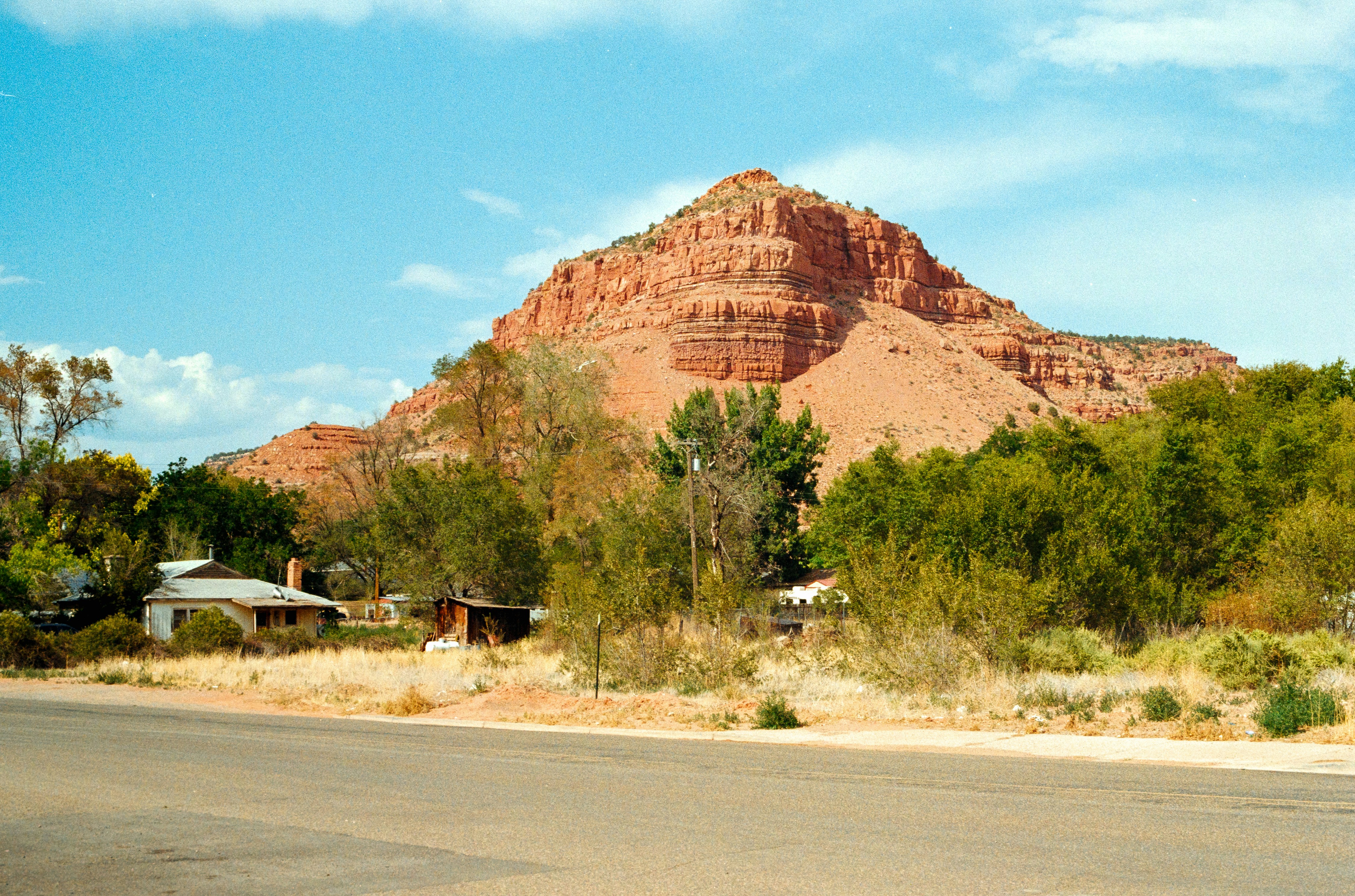 Red Mesa Silhouette: A Tiny Ranch at the Foot of a Prominent Bluff