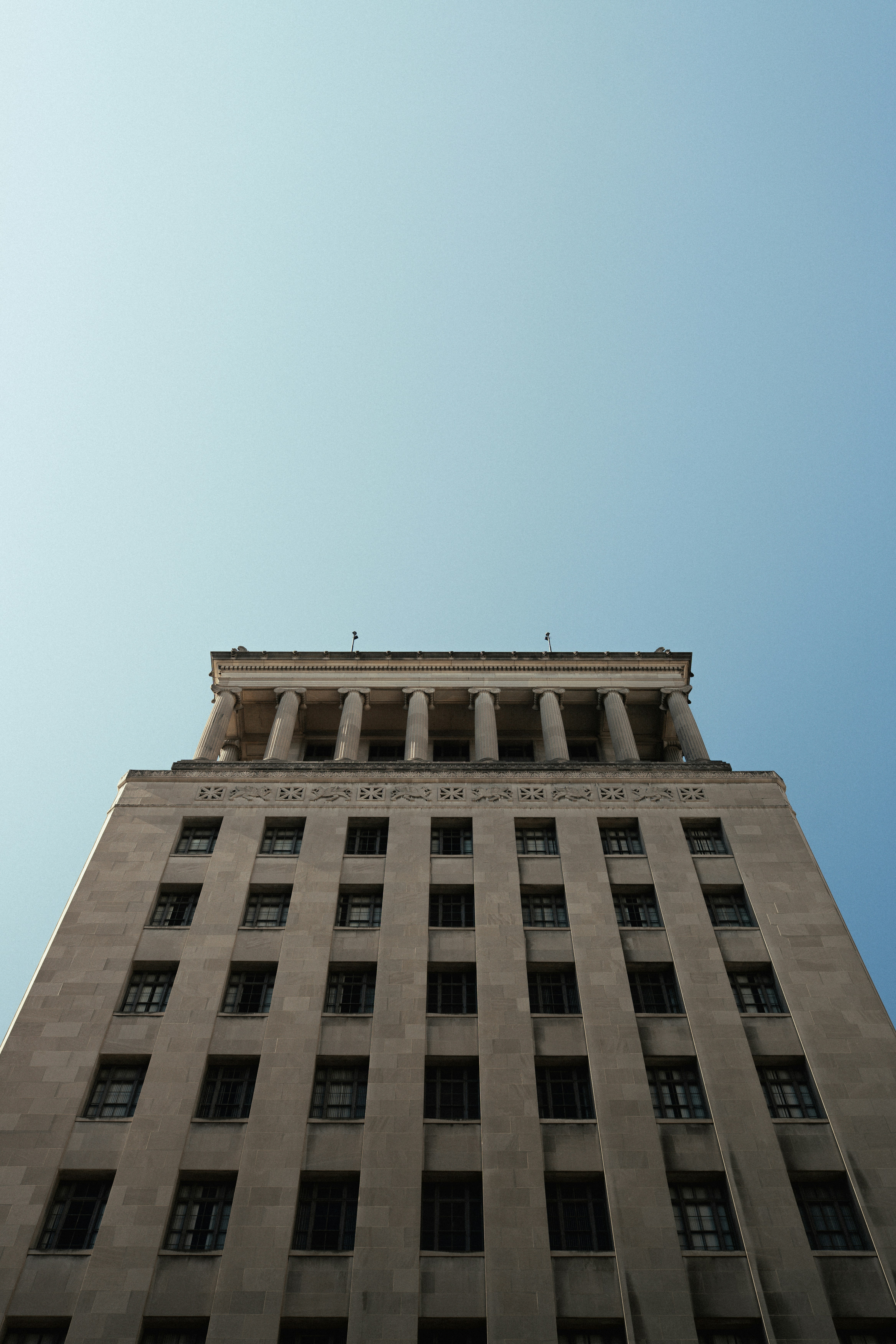 Vertical Atlas: A towering neoclassical façade against a pale sky