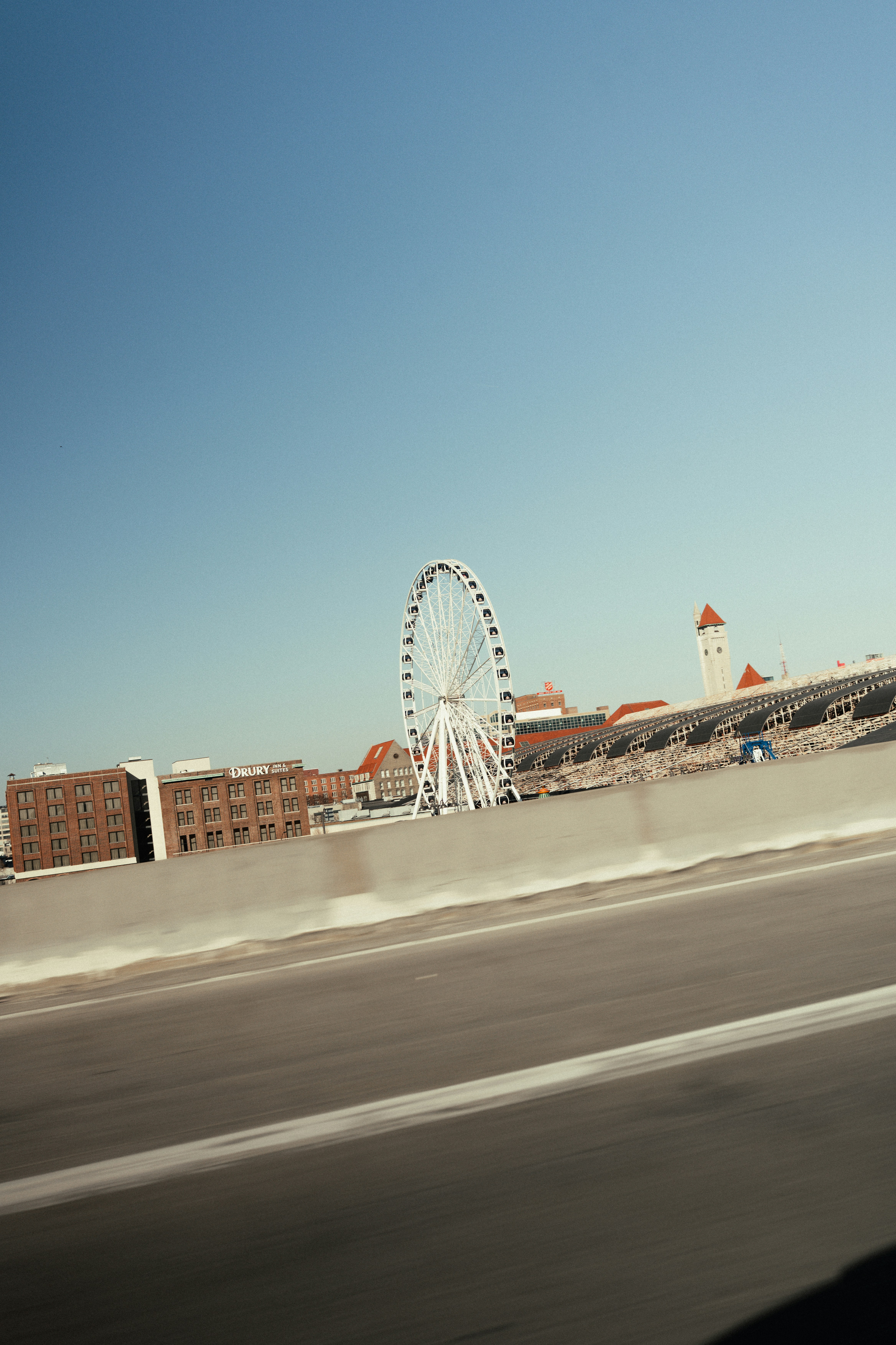 Cityscape on the Move: A Ferris Wheel by the Waterfront