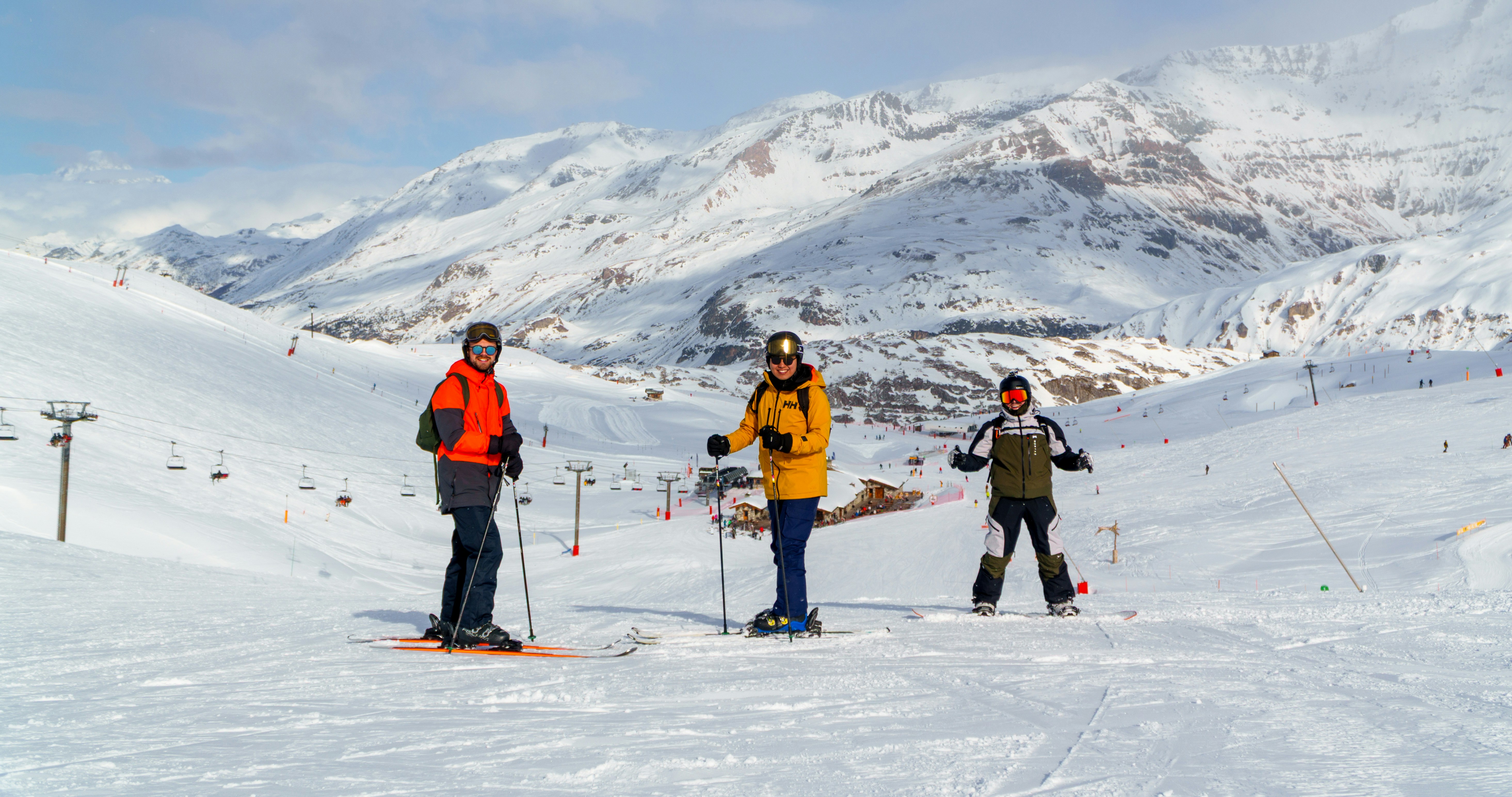 Three Skiers in a Snow-blanketed Alpine Basin
