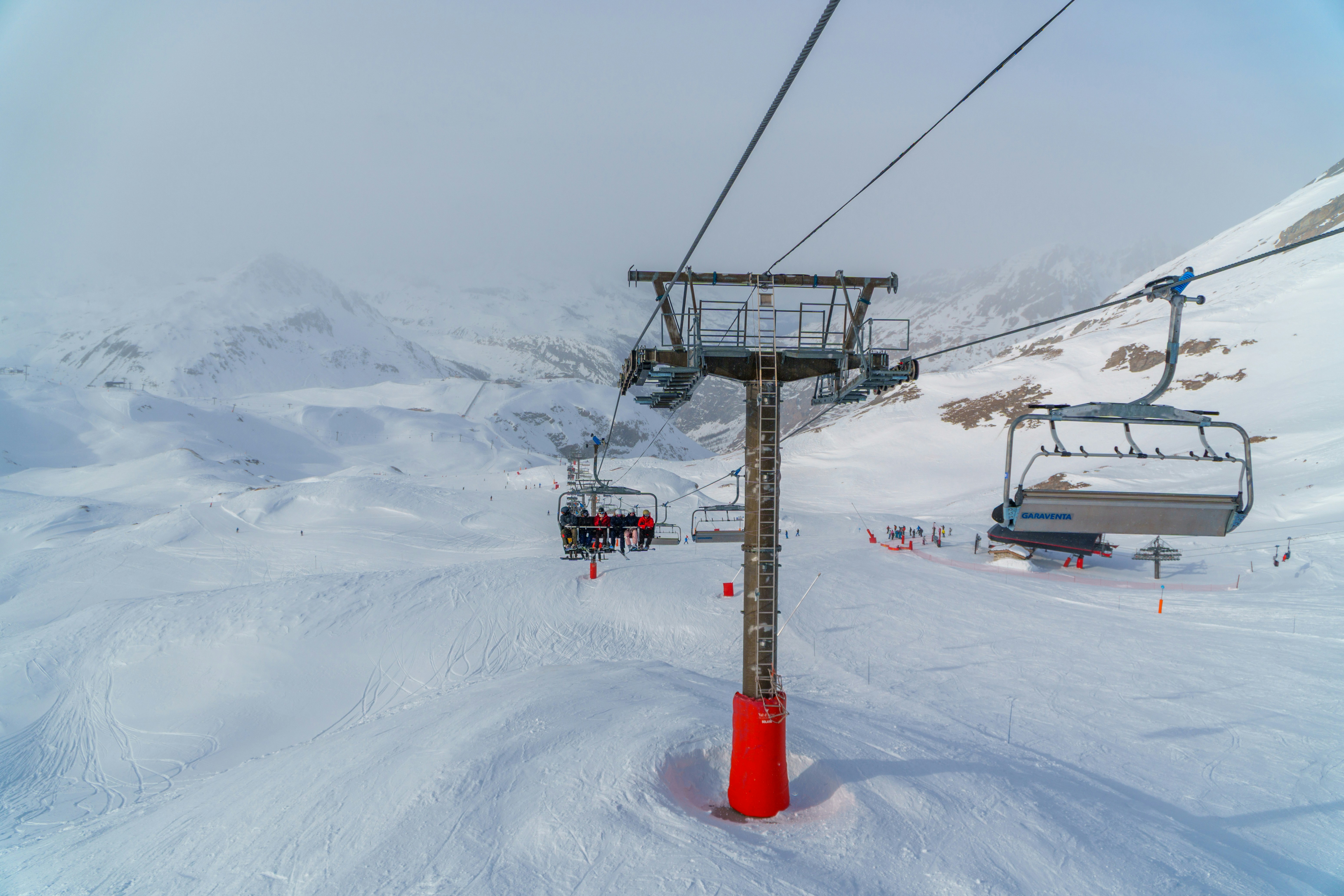 Lift Towers and Snowbound Slopes Under Gray Sky