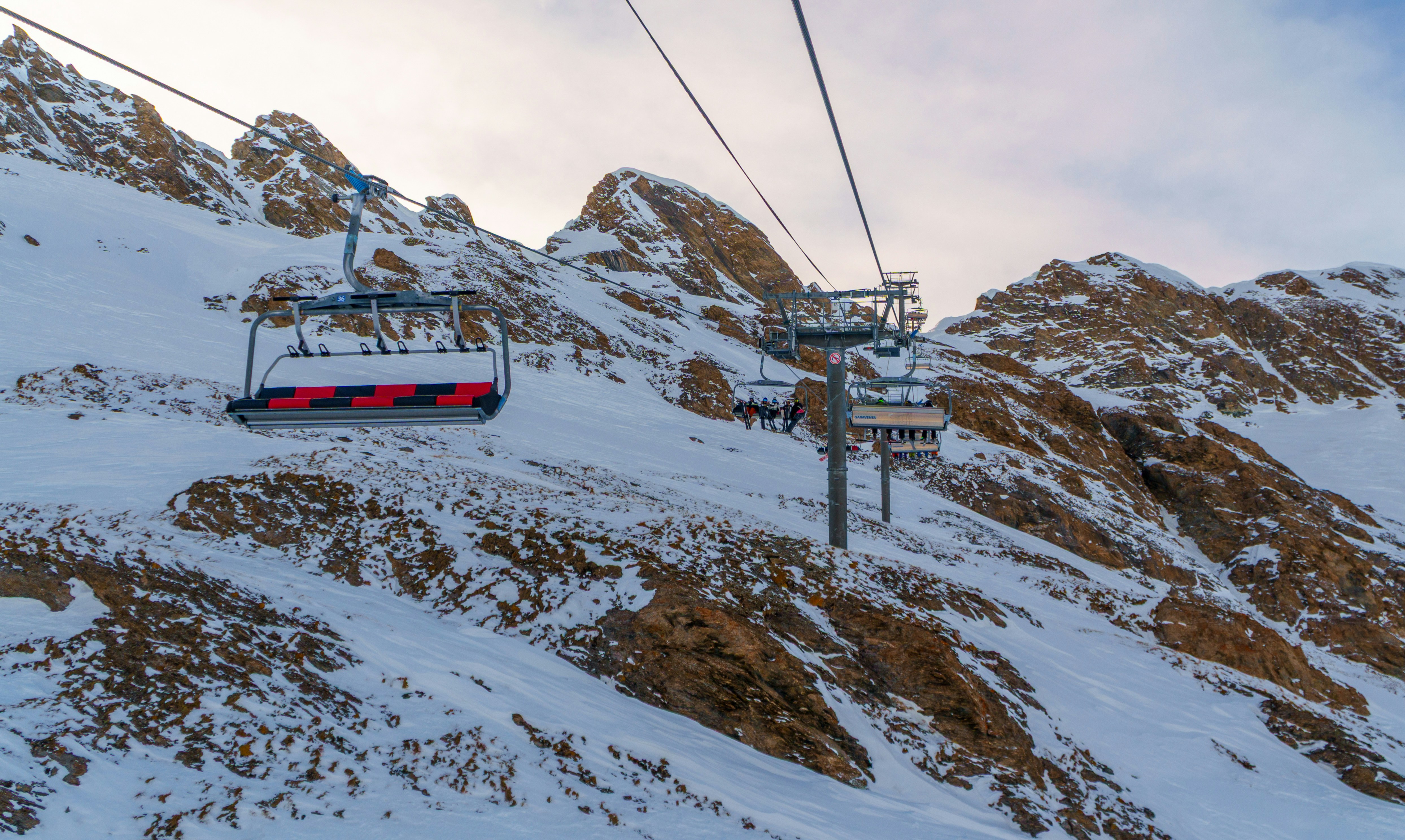 Snow-capped slopes and a lone chairlift climbing toward the crest