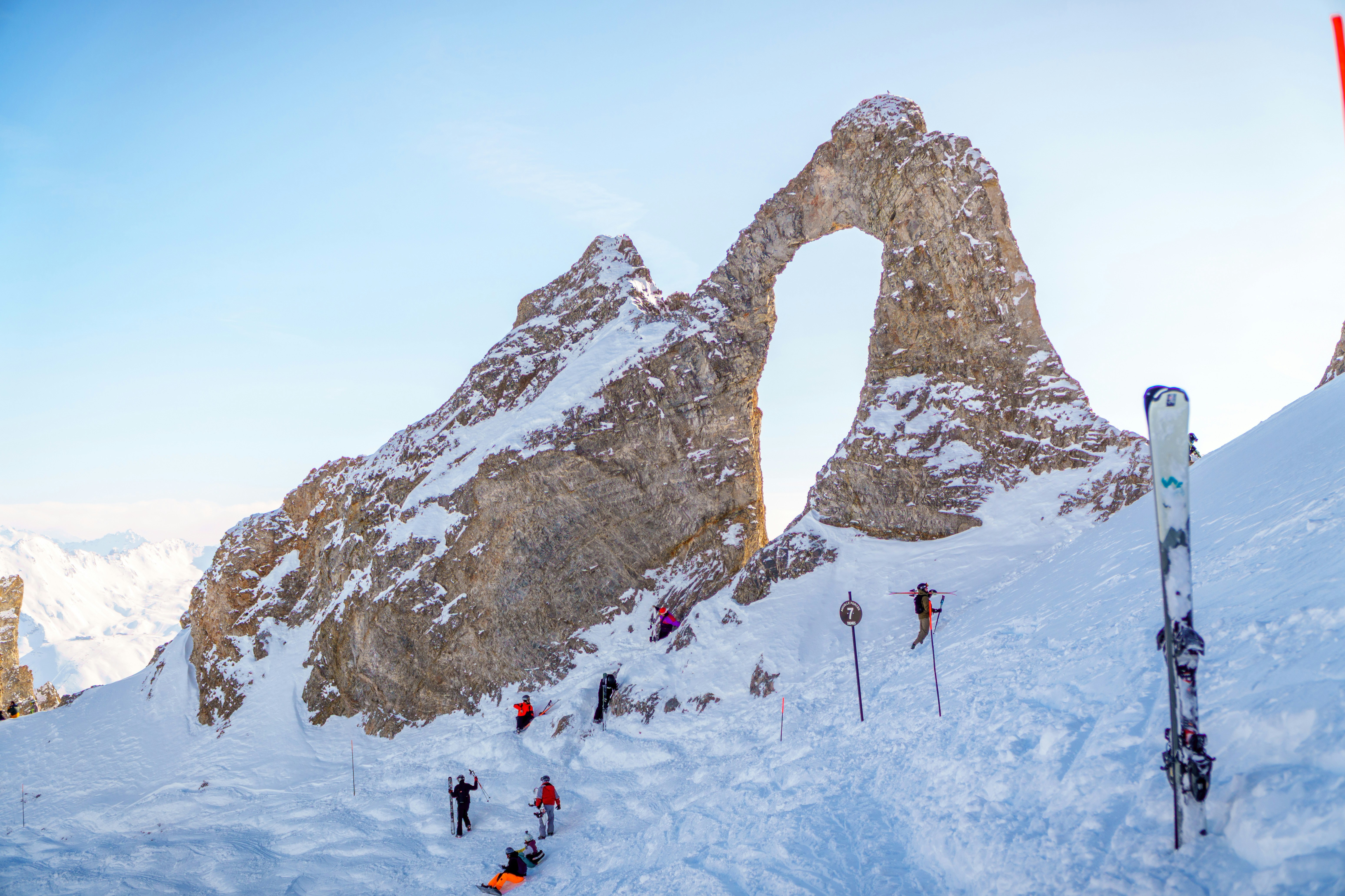 Snowbound Arch: Climbers Halt at the Mountain Gate