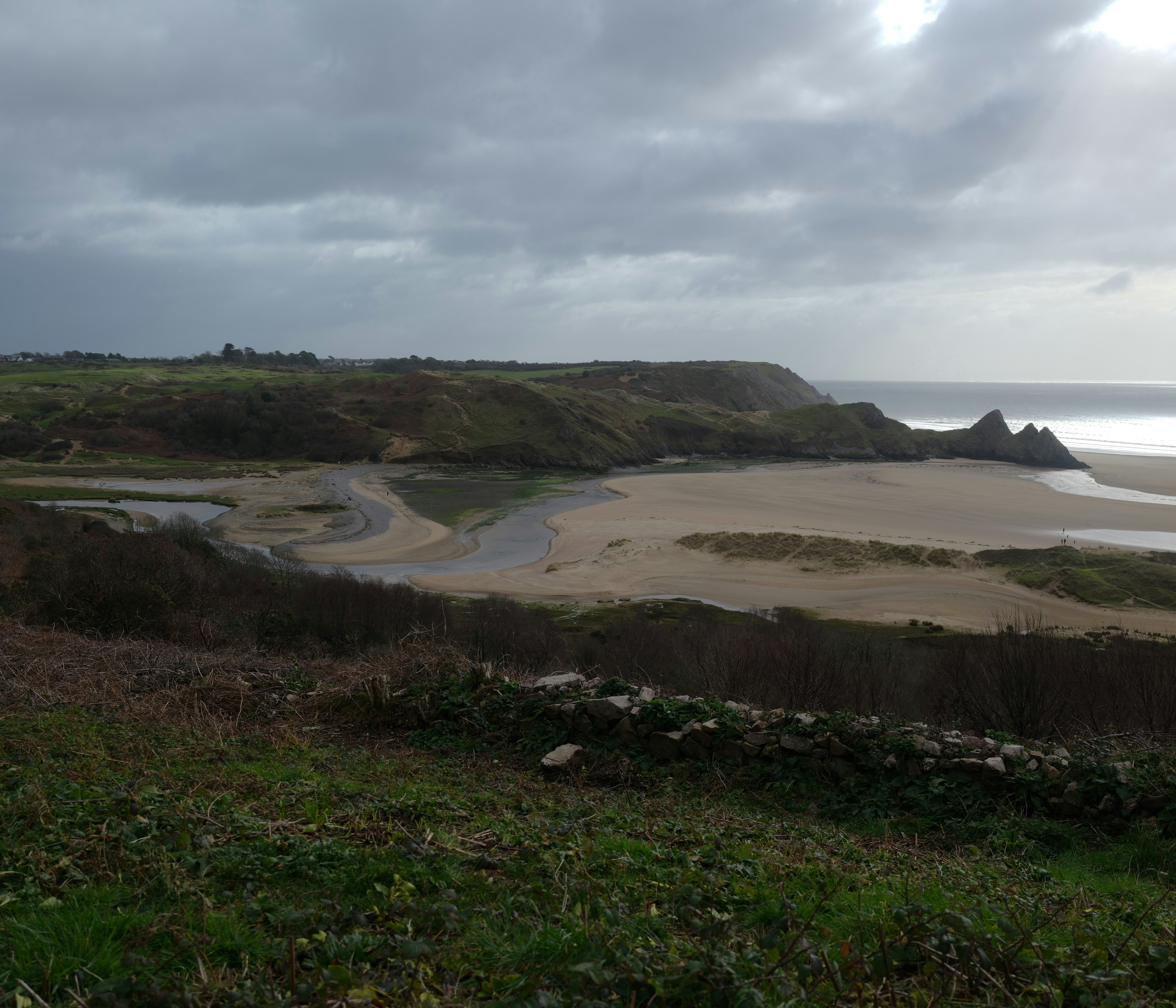 Coastal Plateau meet the Sea: a windswept estuary under overcast skies