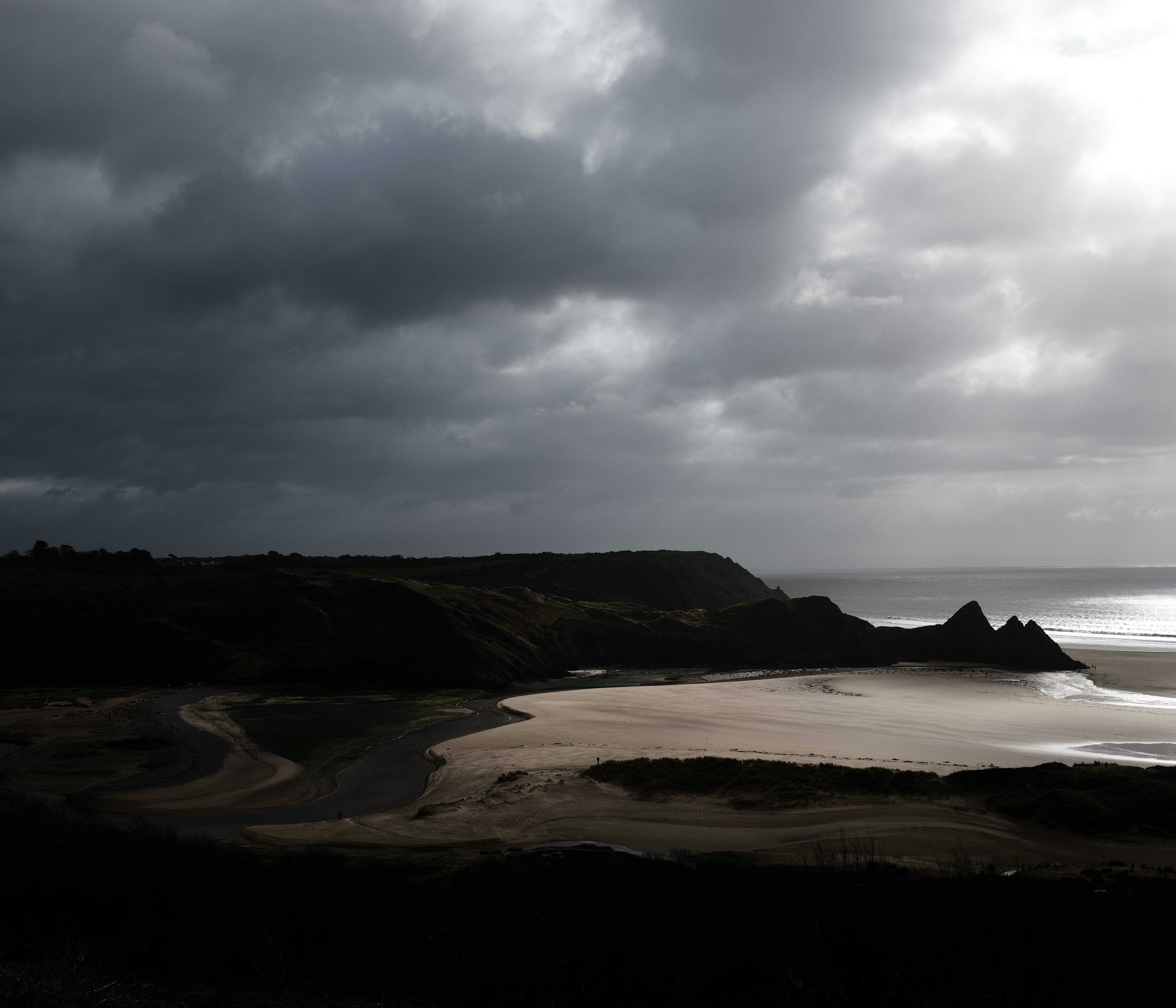 Storm-Soaked Headland Over Silent Shore