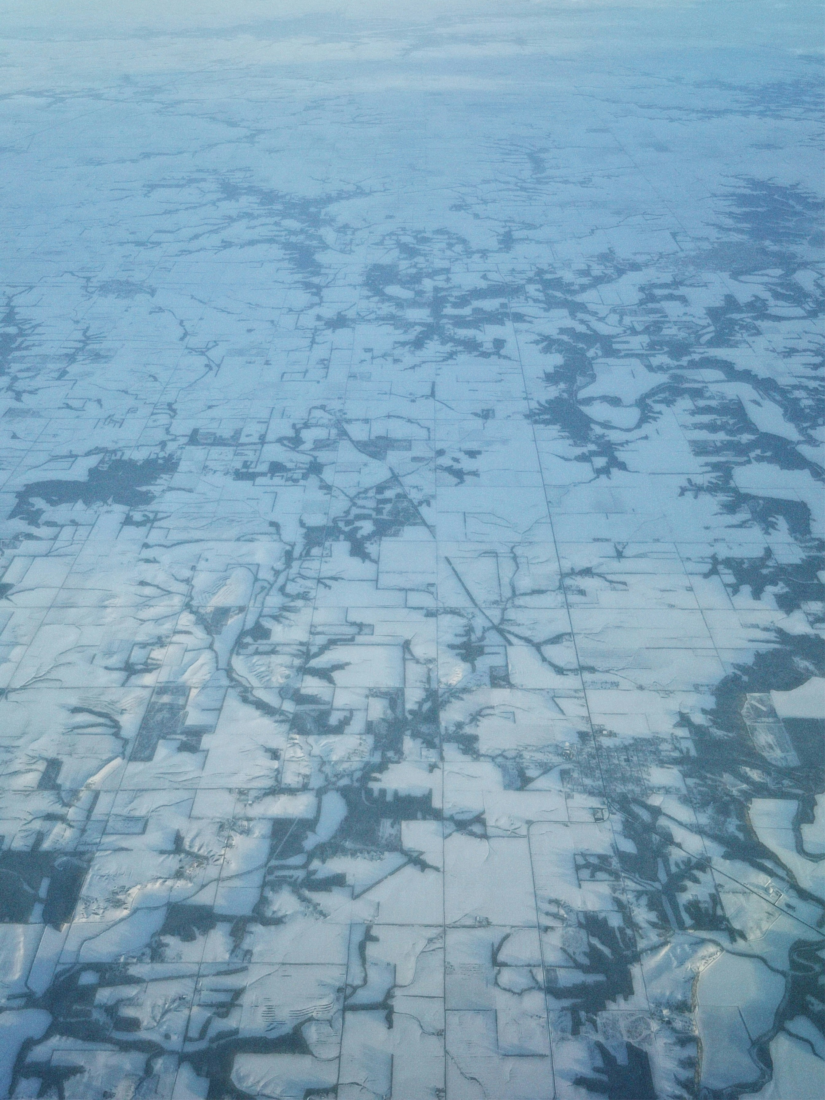 Snow-Creased Grid: Aerial Patchwork of Farmland