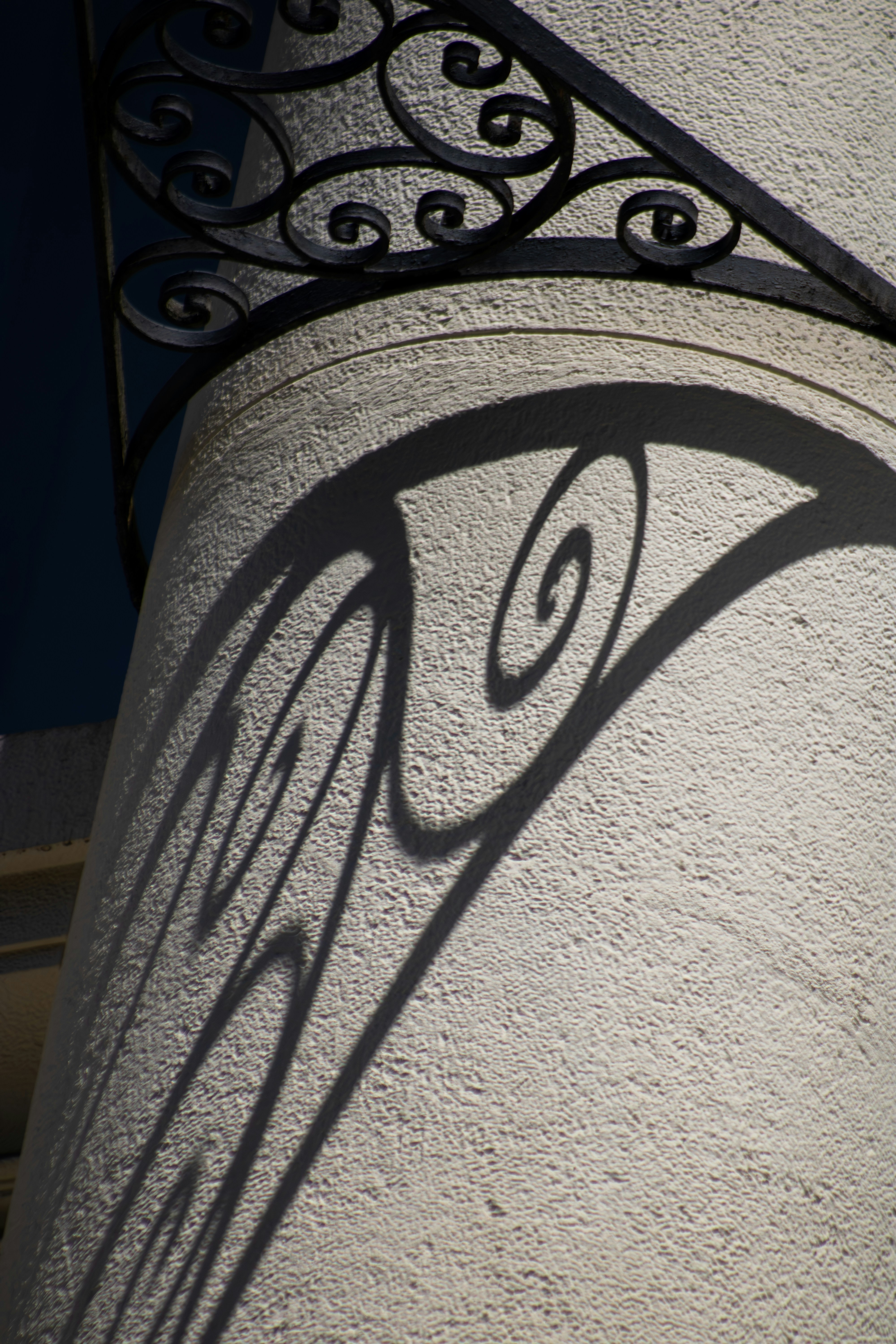 Shadowed Ironwork on Curved Concrete Terrace