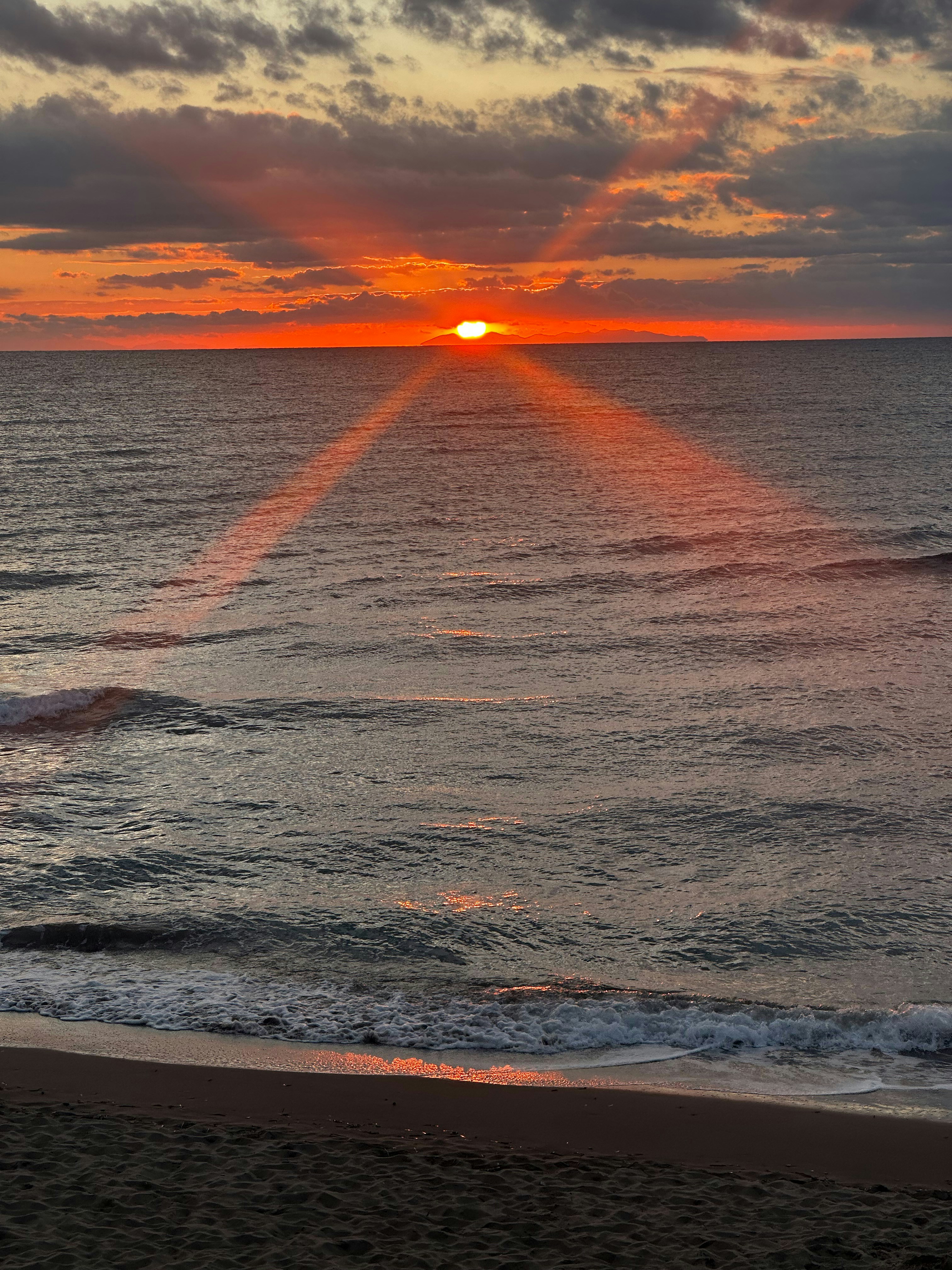 Rising Sun over Quiet Seas: A Beach at Dusk